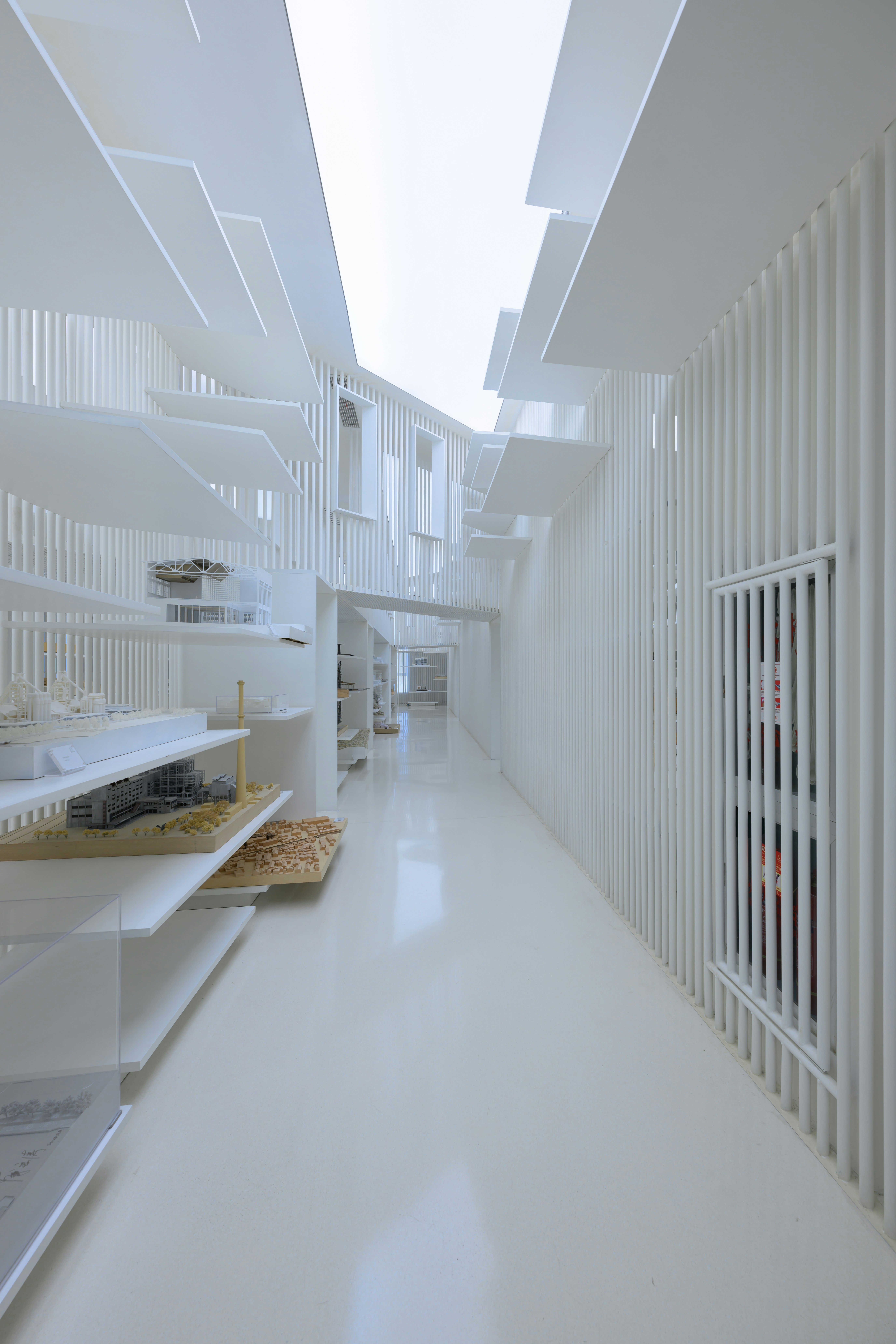 A long white hallway with a bunch of shelves photo – Free Jing'an Image ...