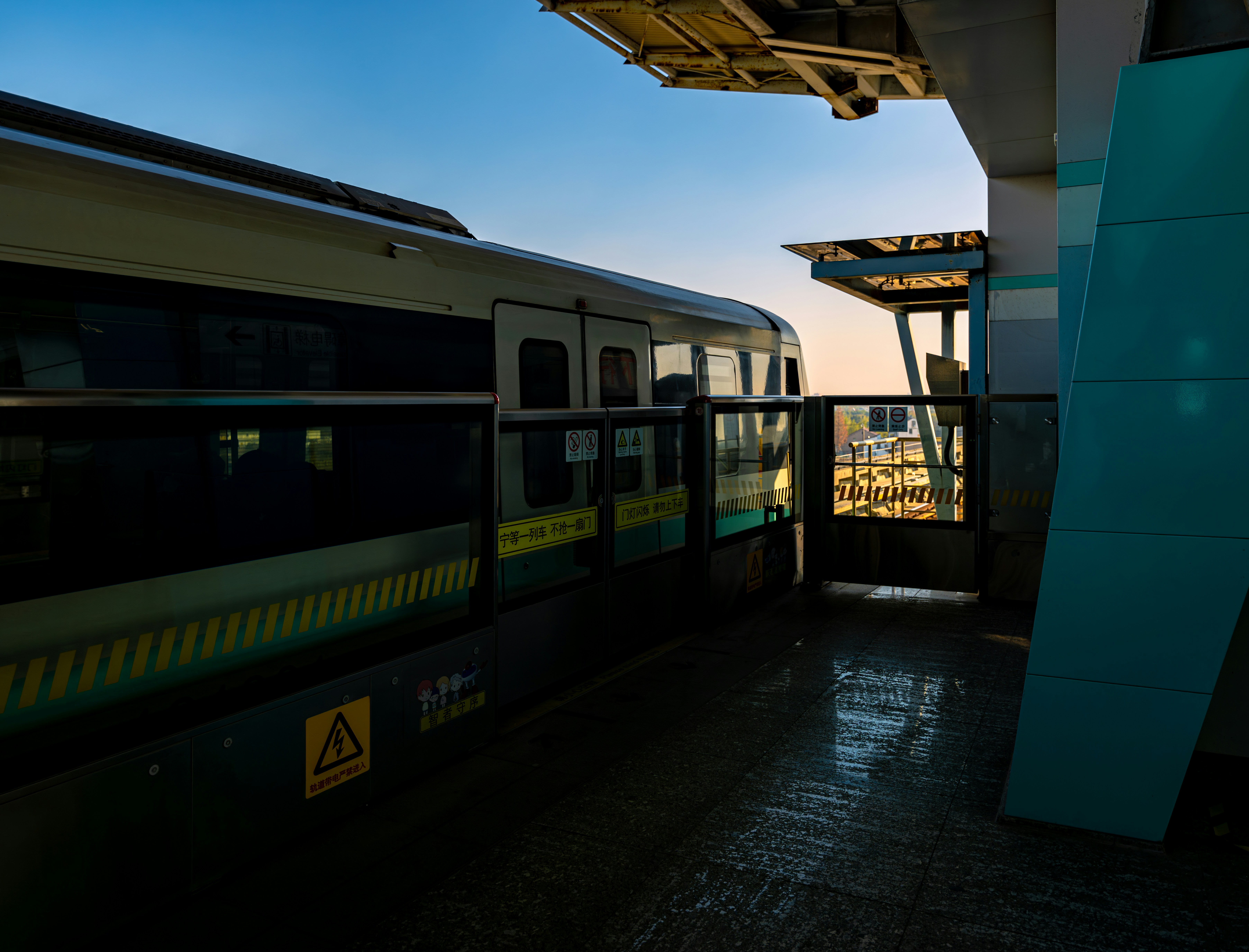 Gaplight at the Platform: Train Silhouette Framed by a Cyan Canopy