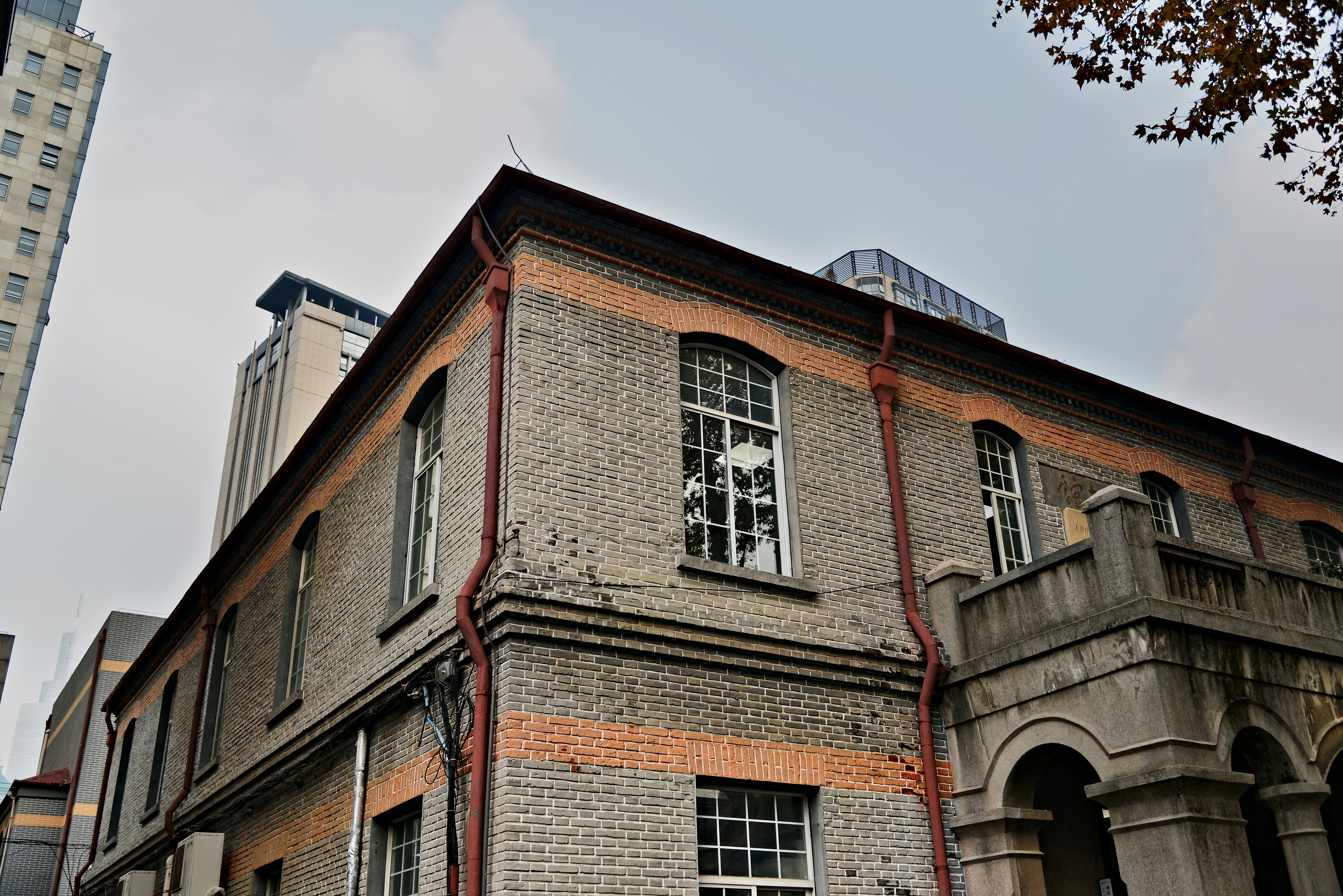 Brick Chronicle at the City Edge: Weathered Facade Meets Rising Towers