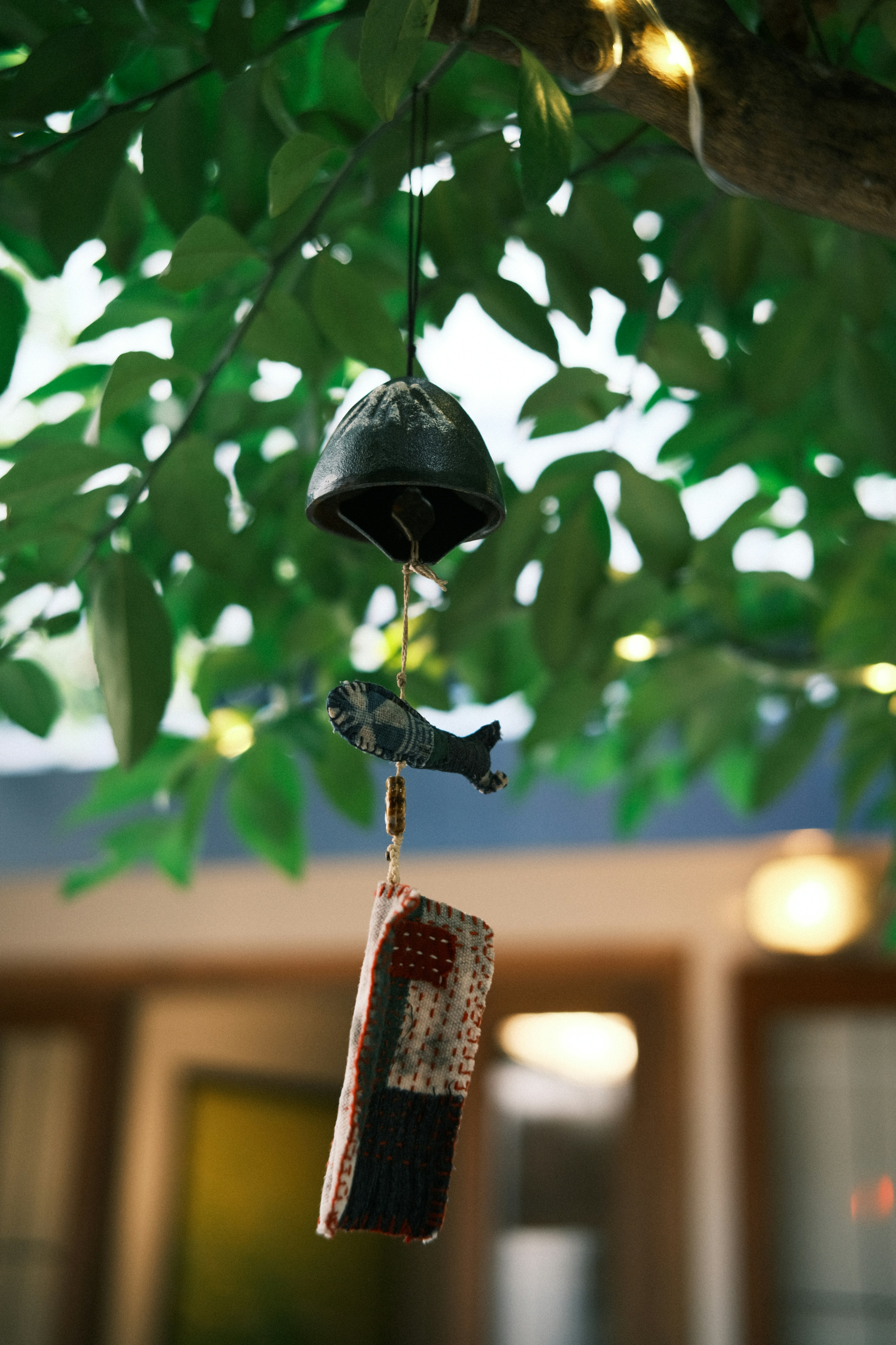 A bell hanging from a tree in front of a house photo – Free Animal ...