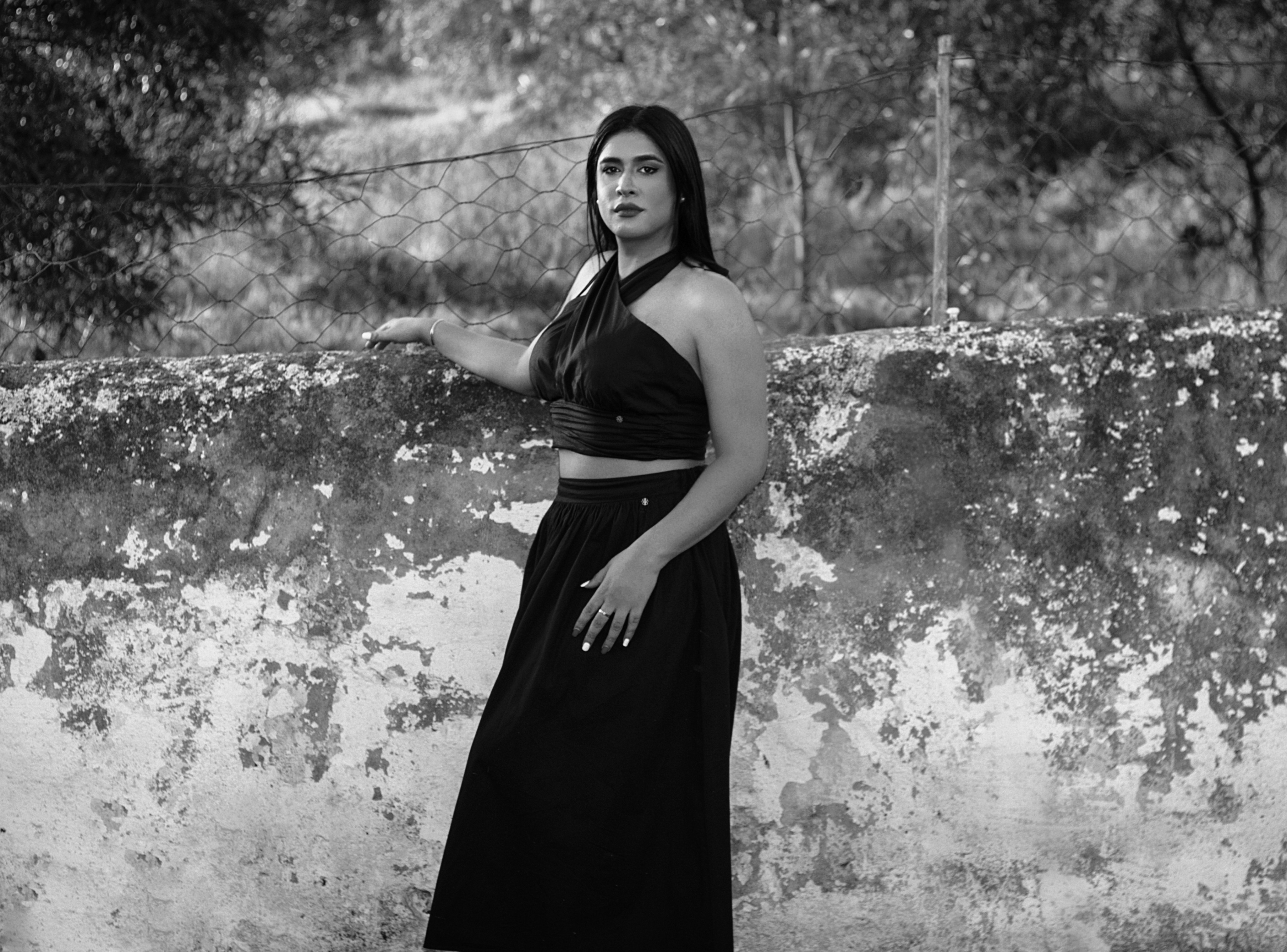 A woman standing in front of a stone wall photo – Free Raw portrait ...