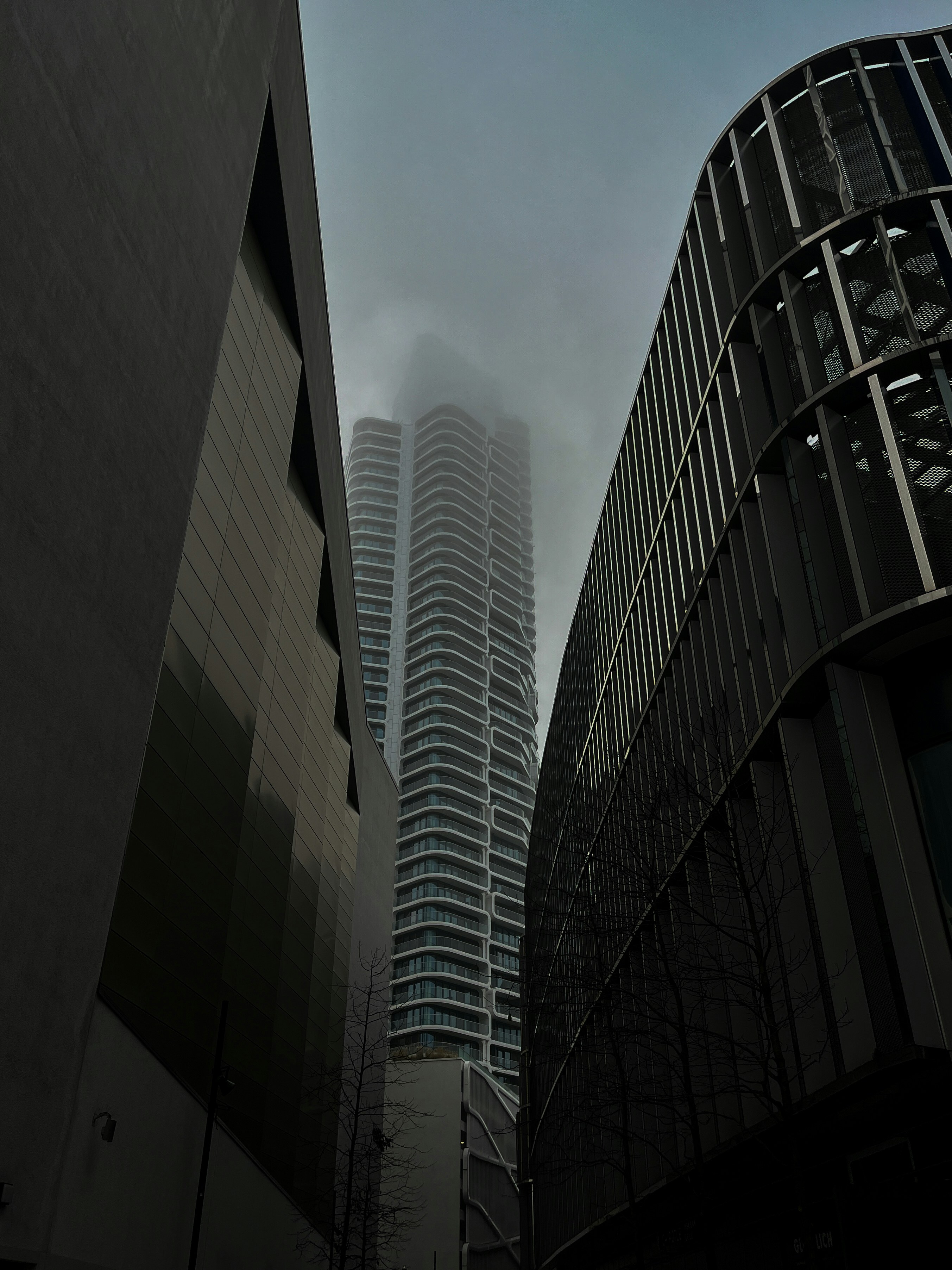 Spire Between Shadows: A Narrow Urban Canyon Reaching Skyward