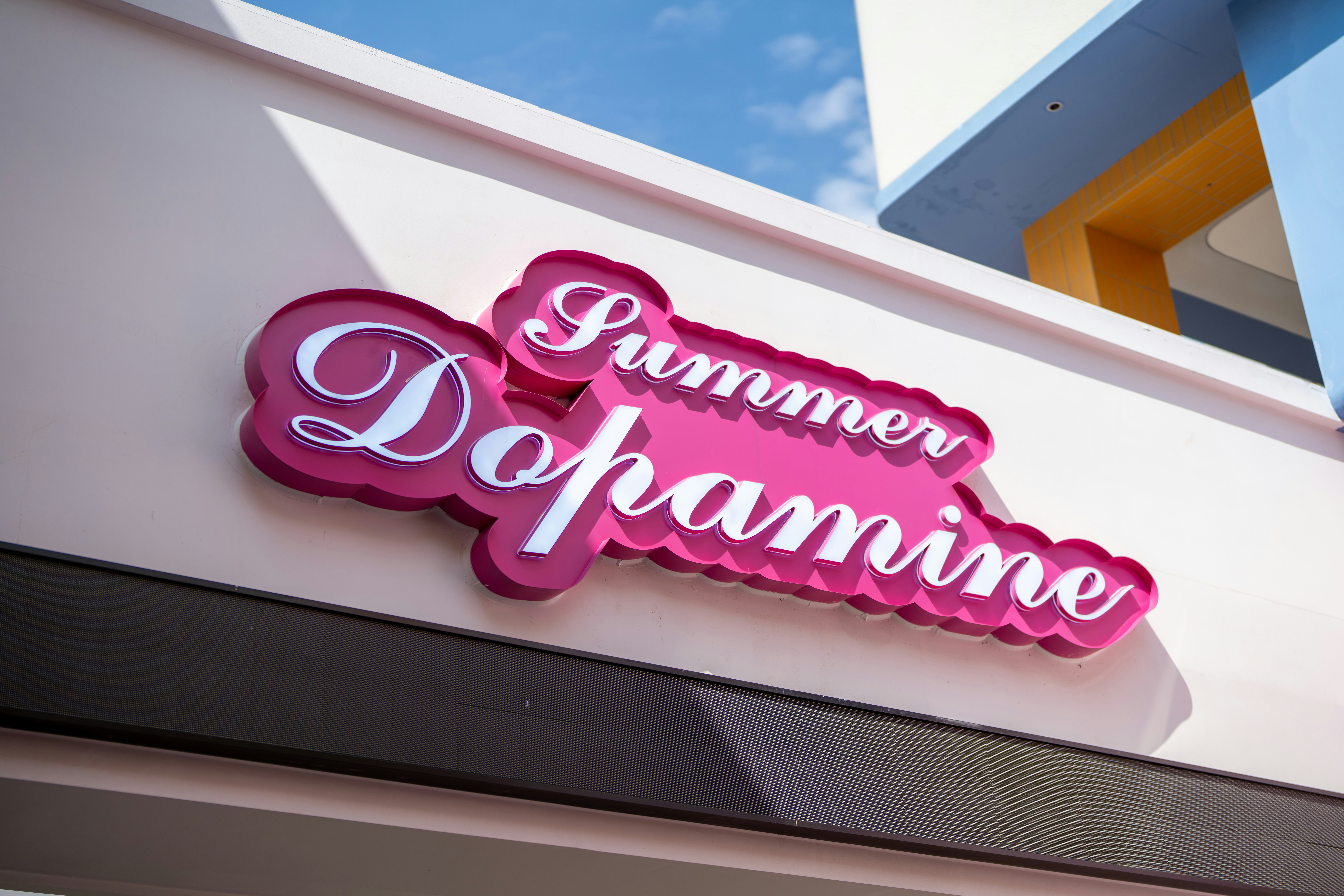 Pink Neon on Pastel Facade: Summer Dopamine Sign