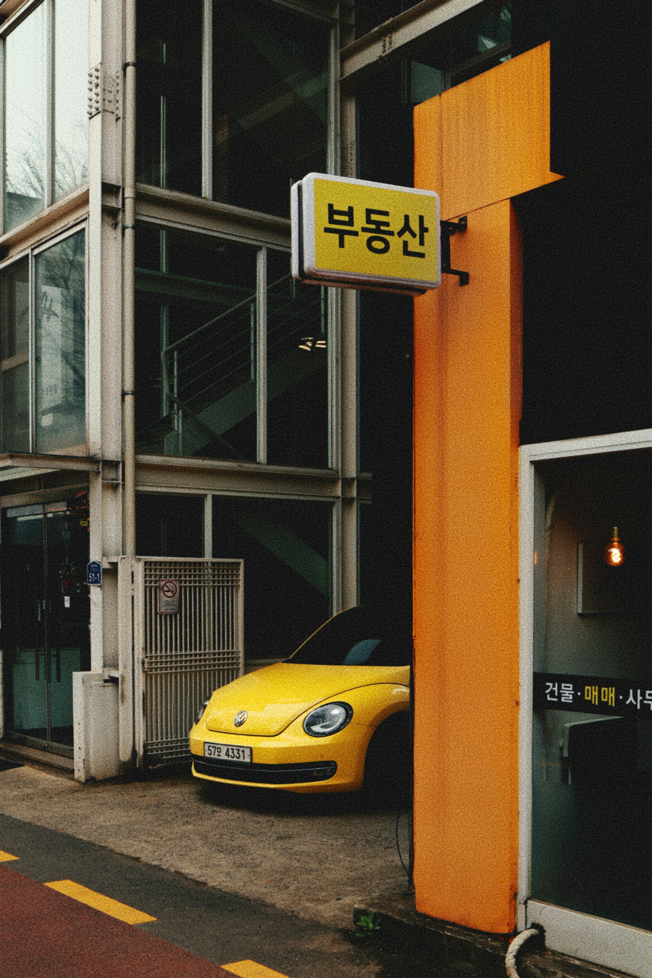 A yellow car parked in front of a building photo – Free Car Image on ...
