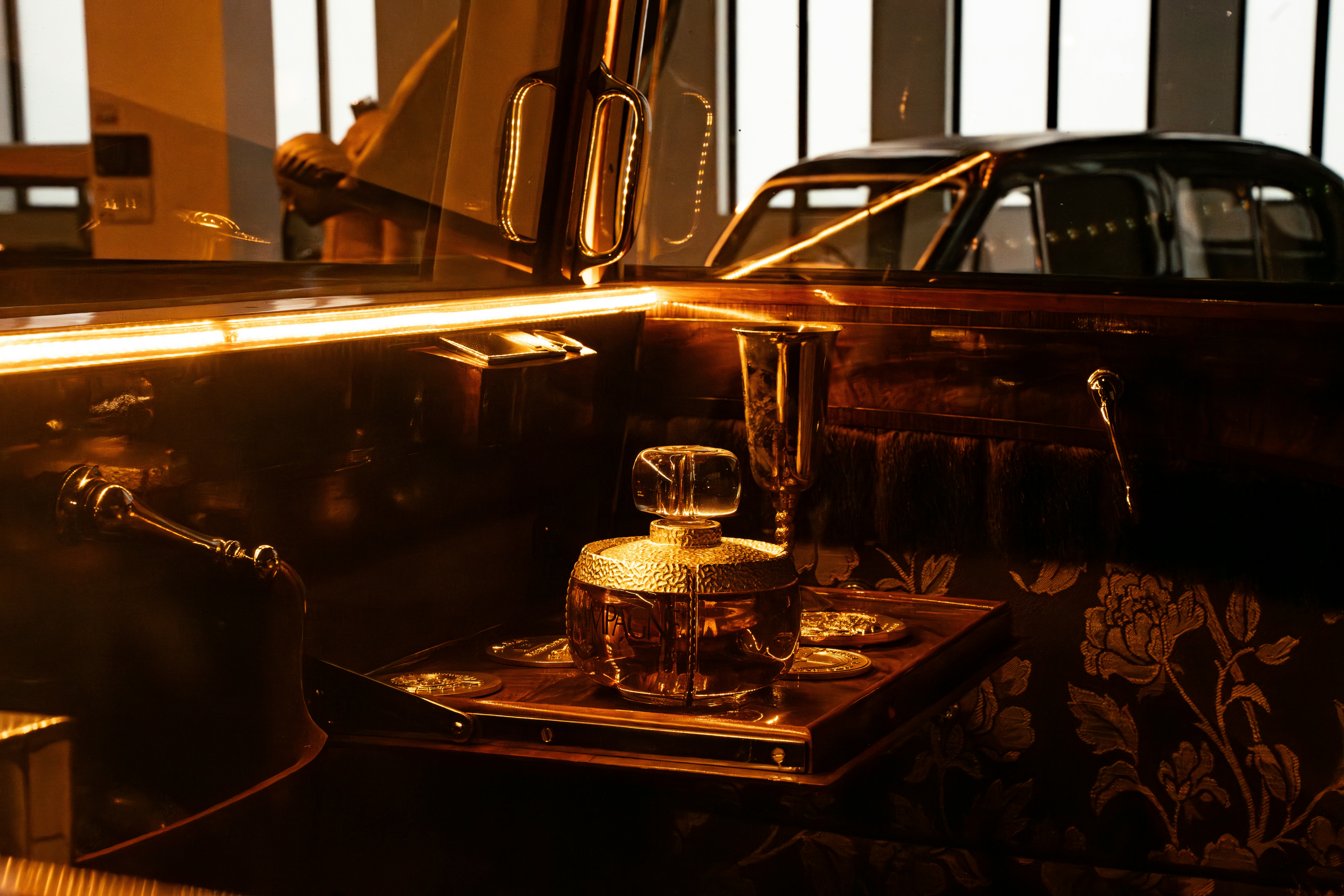 Amber Quiet: Glass Decanter Resting on Velvet in a Vintage Car Lounge