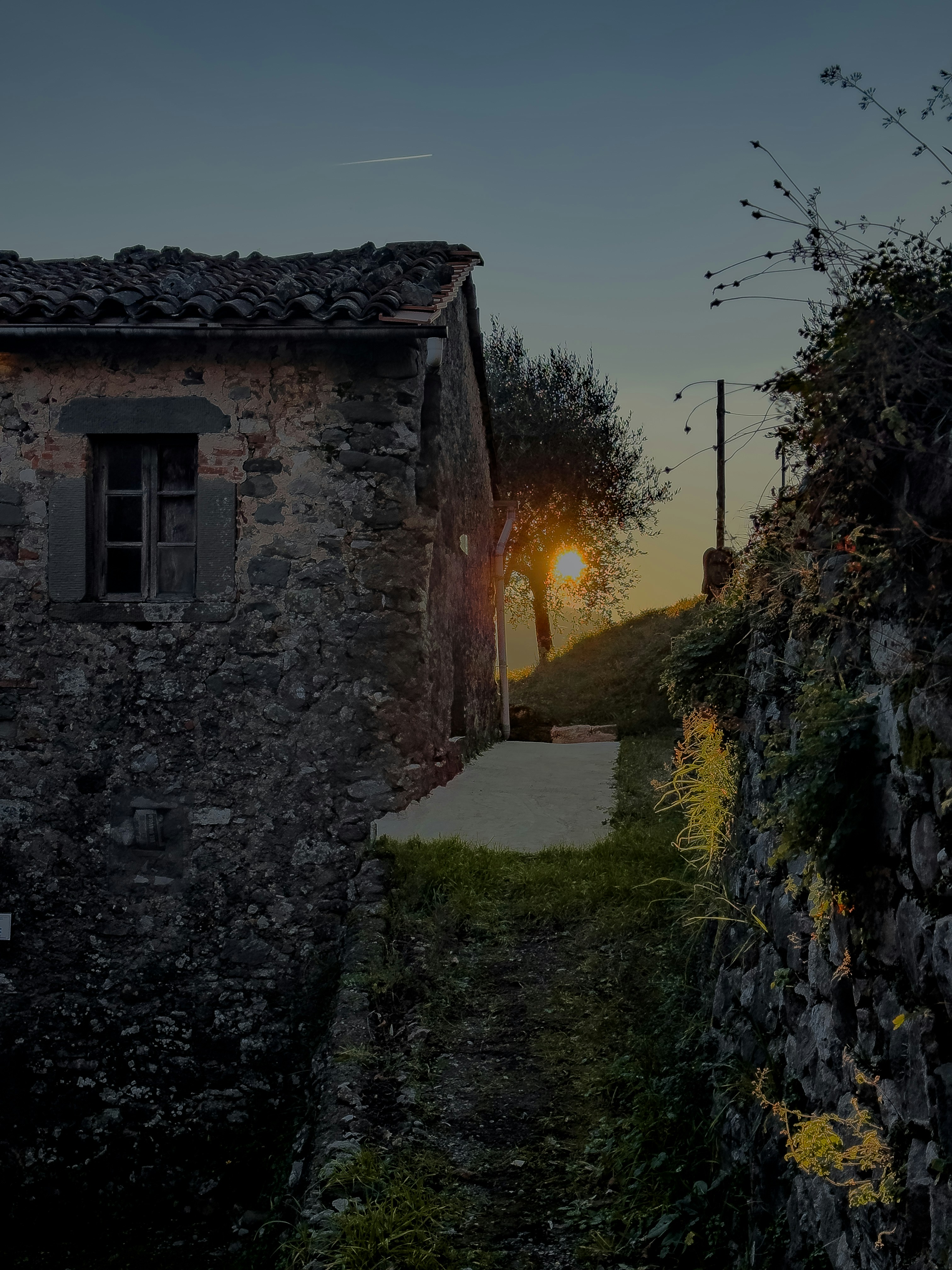 A stone building sitting next to a lush green field photo – Free ...