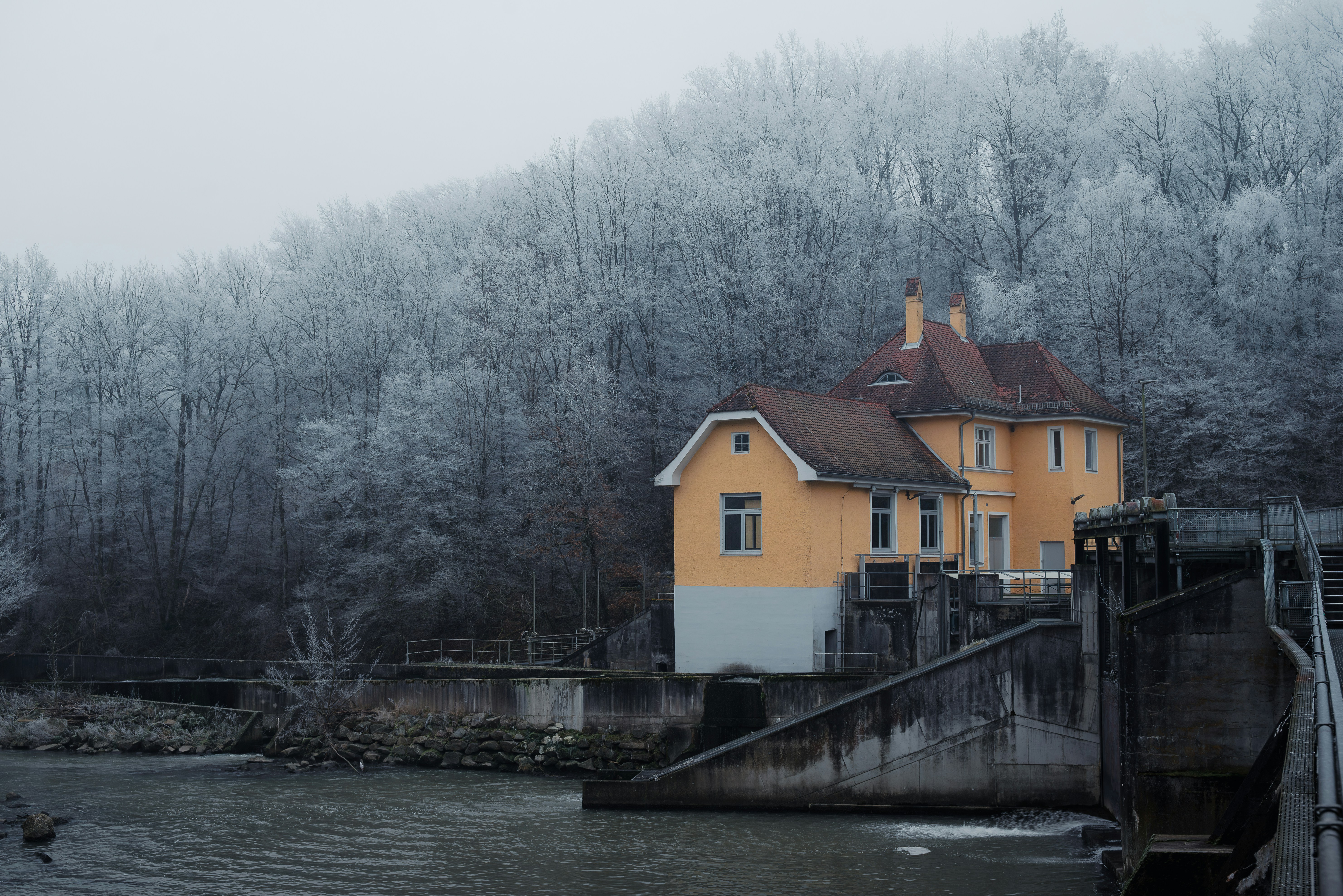 Amber House Over the River: Frost-Kissed Woods and a Quiet Dam
