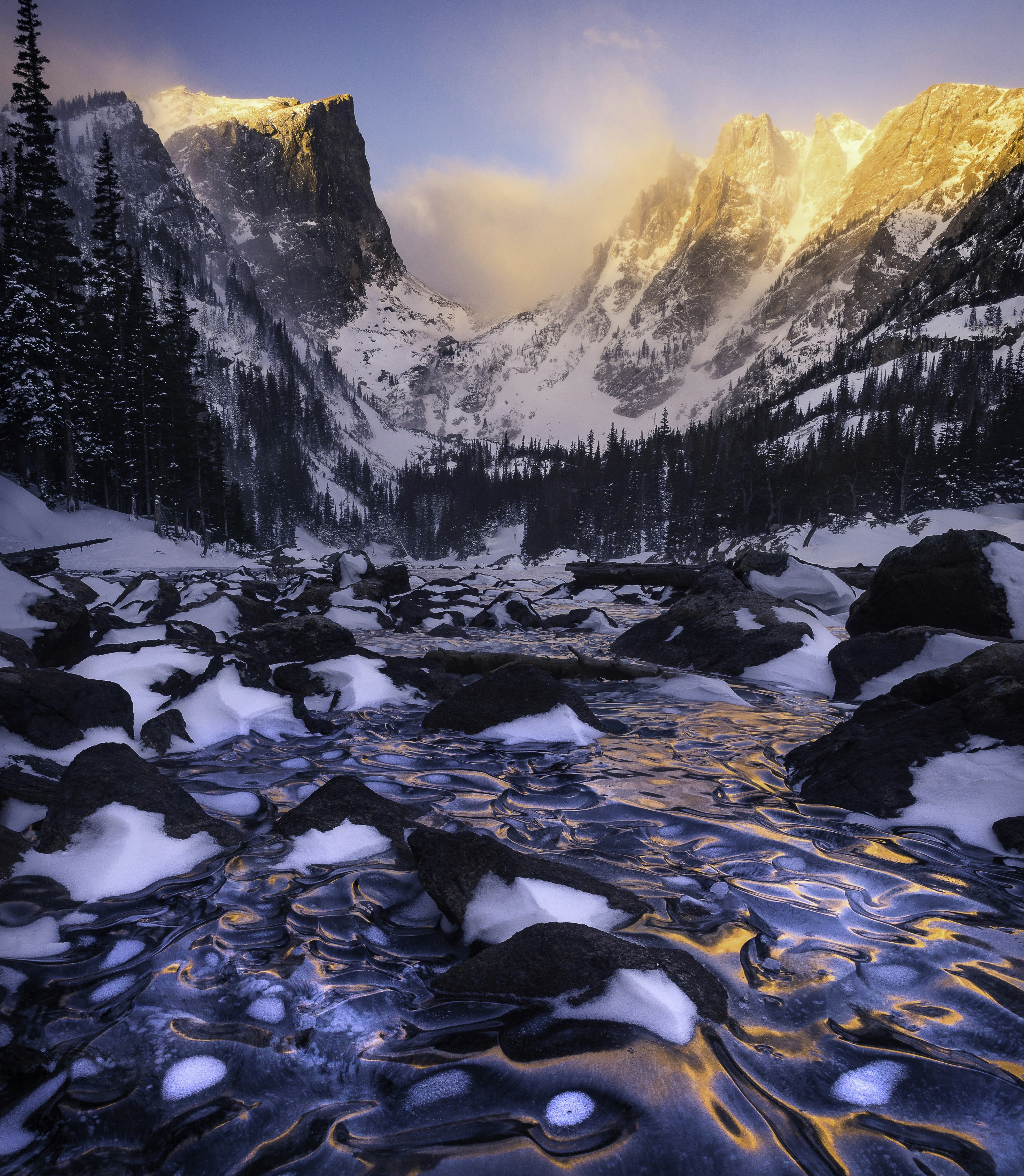 Sunlit Peaks Over a Frozen Riverbed