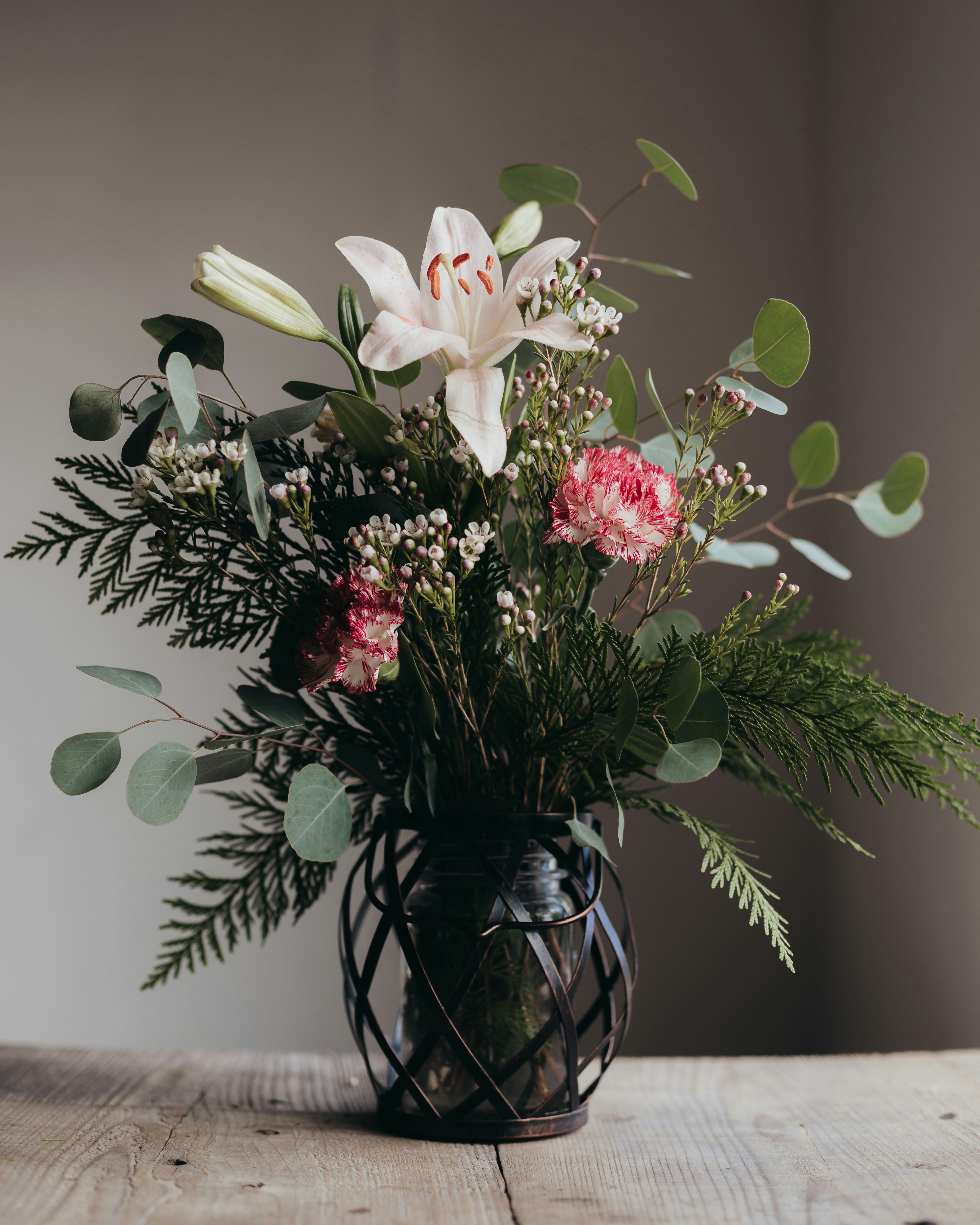 A vase filled with flowers on top of a wooden table photo – Free ...
