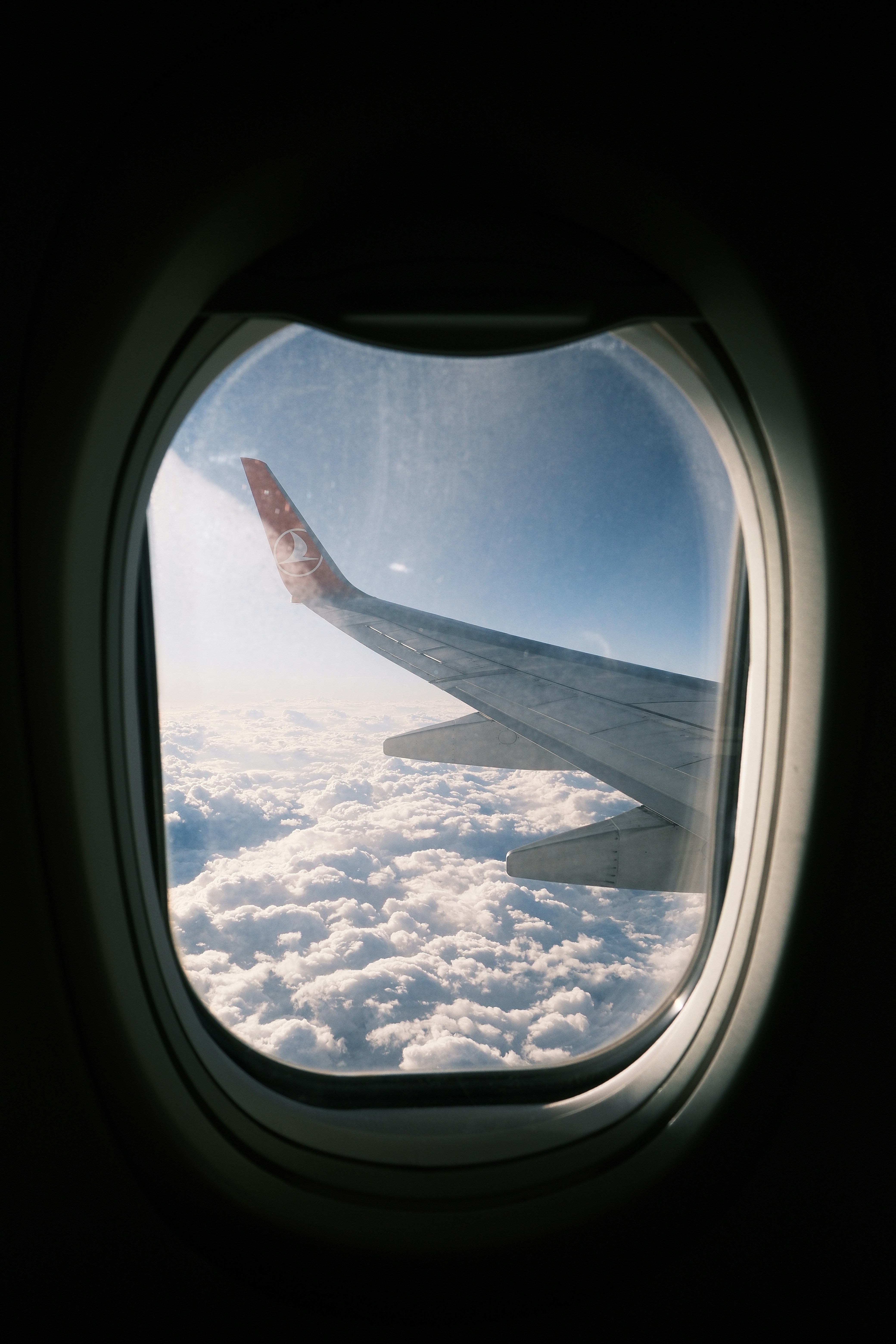 A view of the wing of an airplane through a window photo – Free Clouds ...