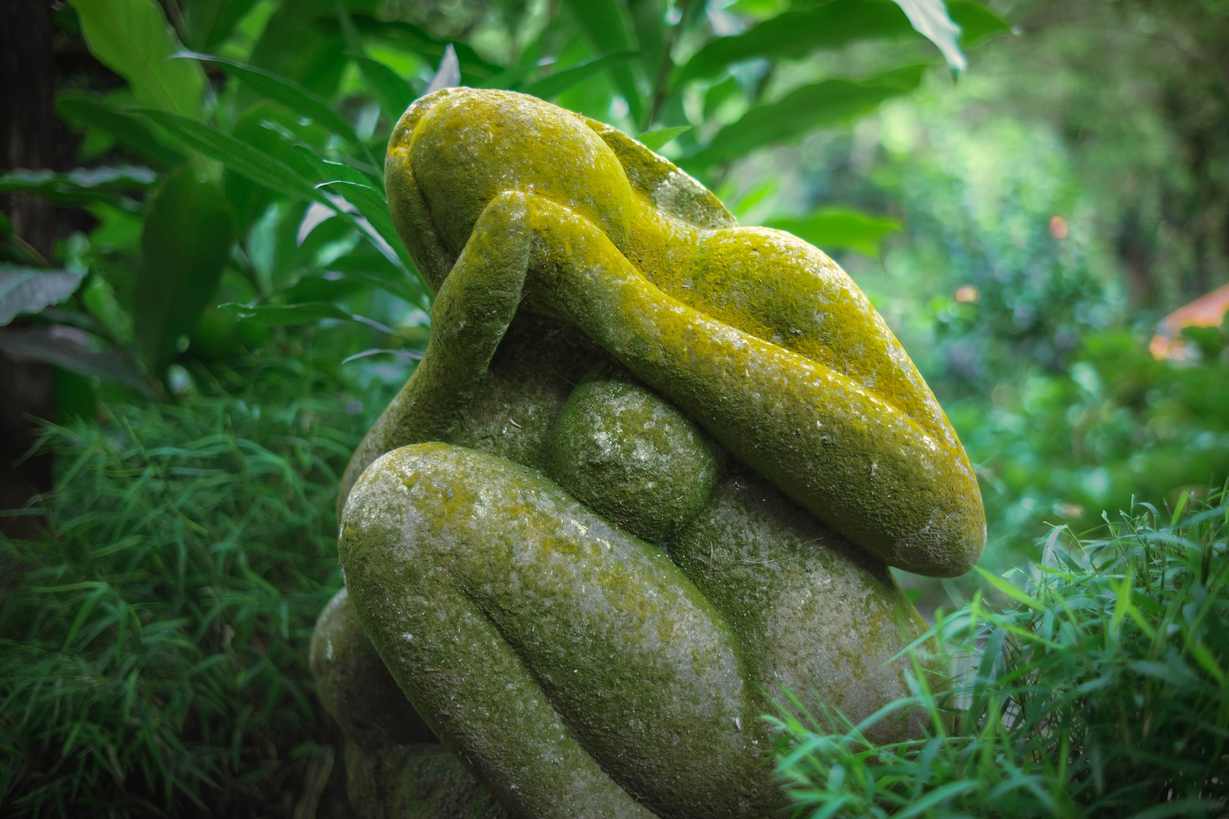 Verdant Spiral: A Moss-Wrapped Stone Stack in a Quiet Garden