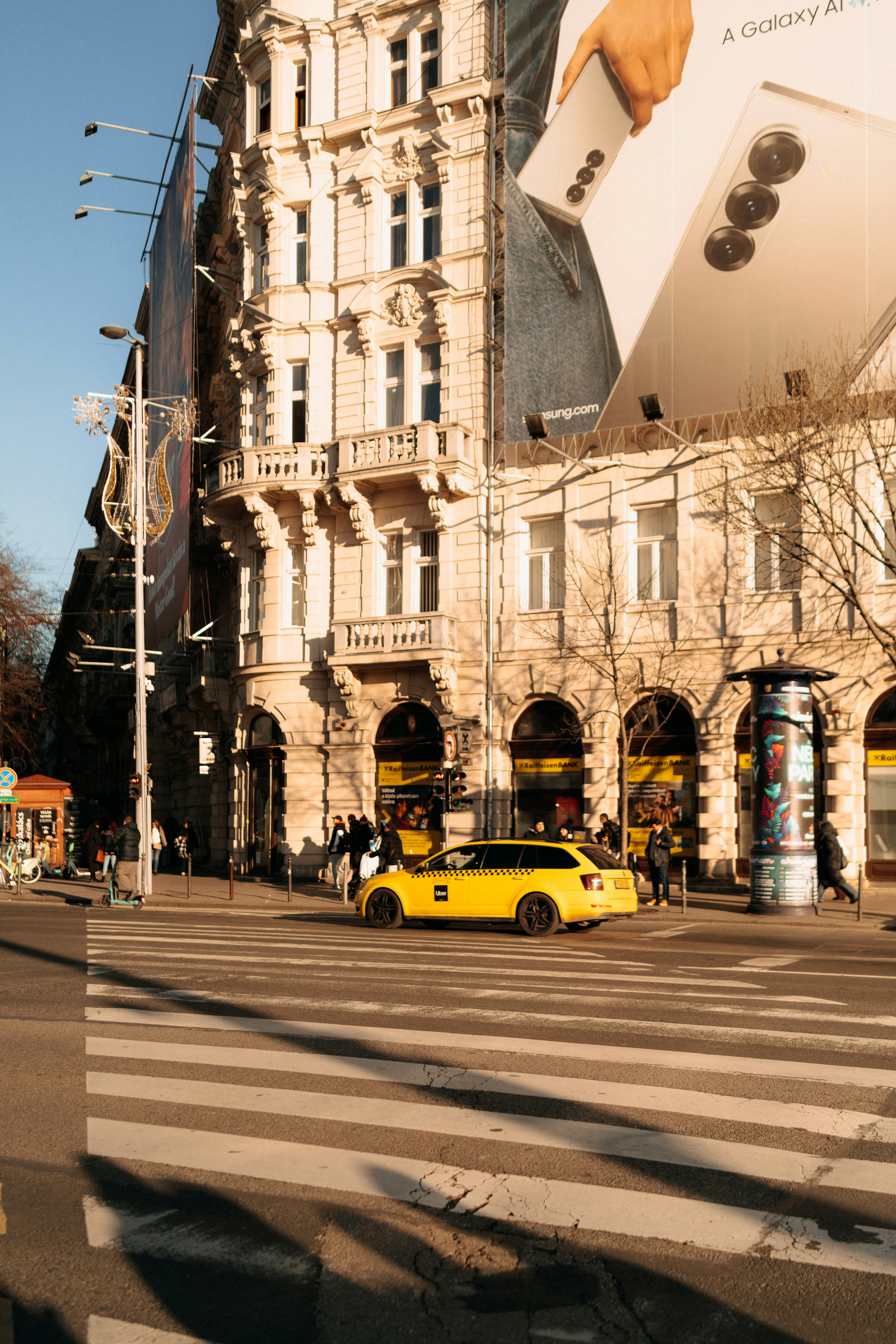 Sunlit Yellow Taxi Anchors a Marble-Fronted City Street