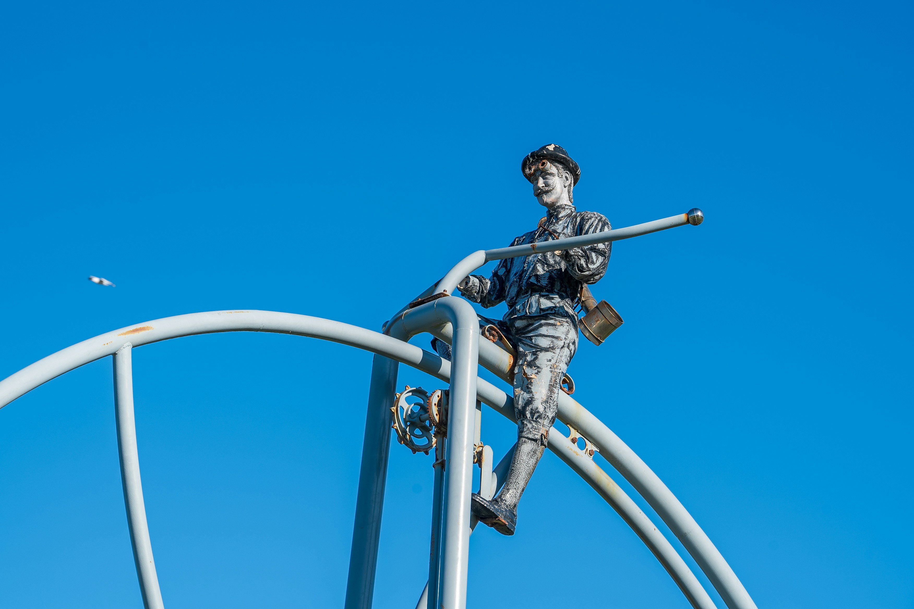Vaulting Rider: A Climber Statue Against a Cerulean Sky