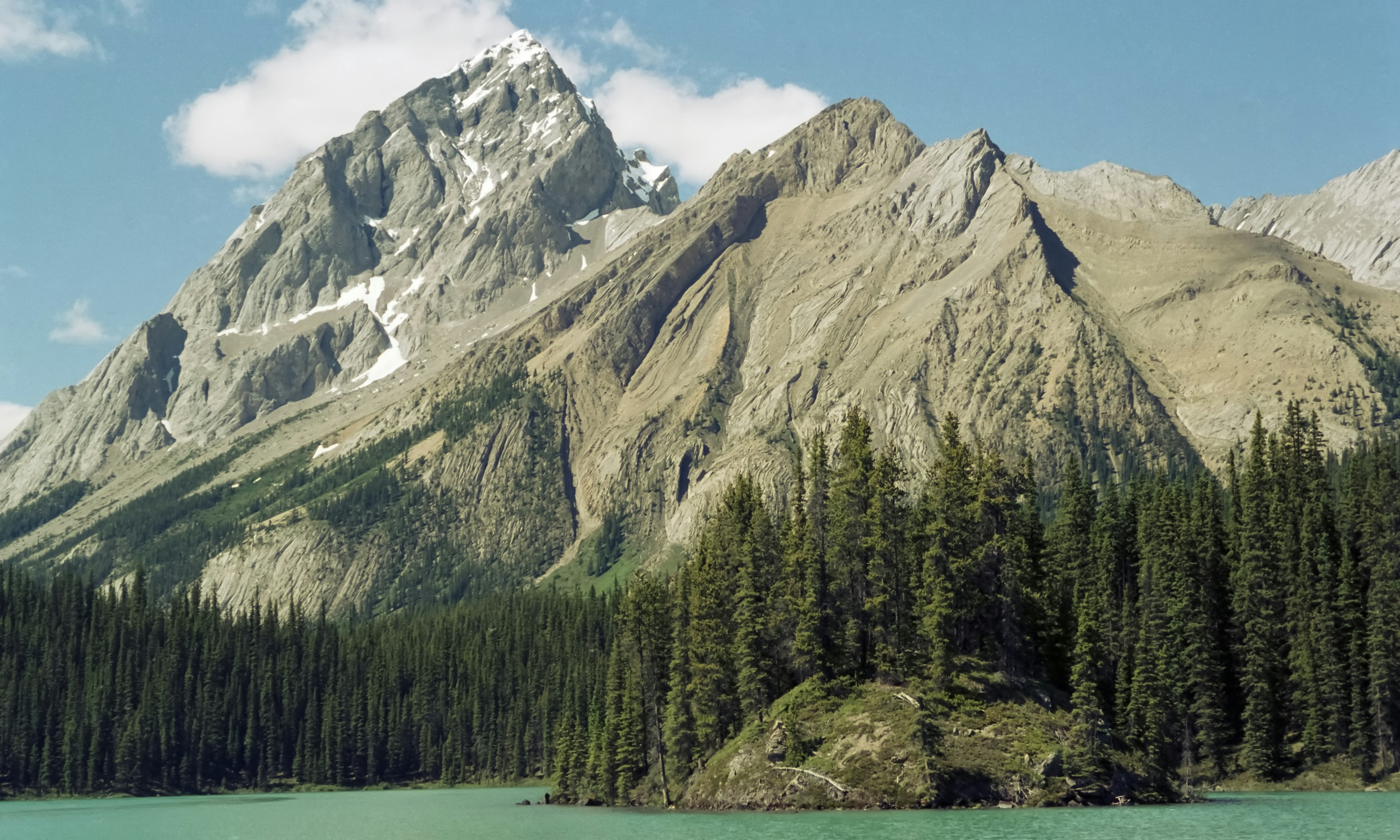 A mountain range with a lake in the foreground photo – Free Samson peak ...