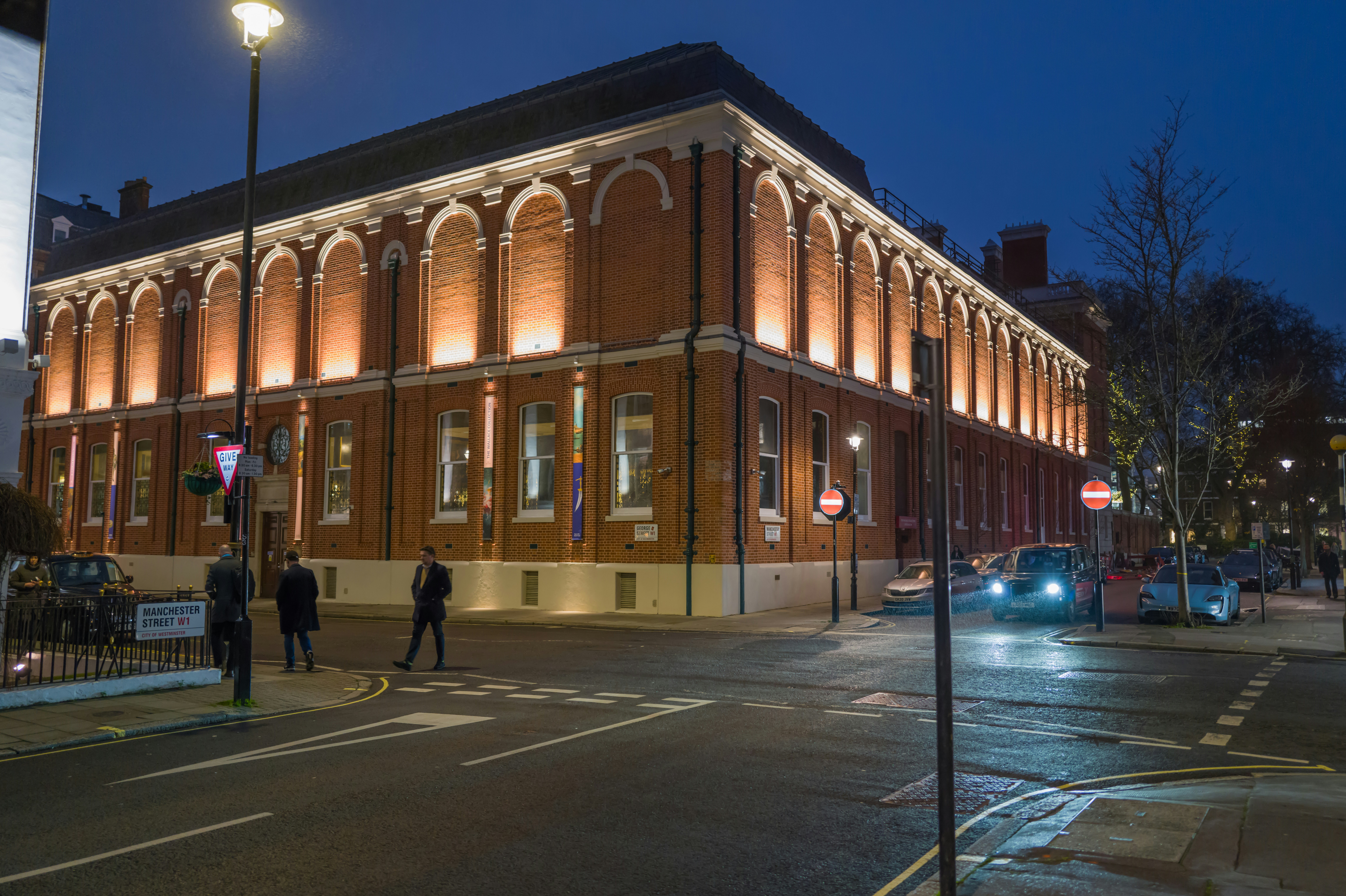 A large brick building sitting on the corner of a street photo – Free ...