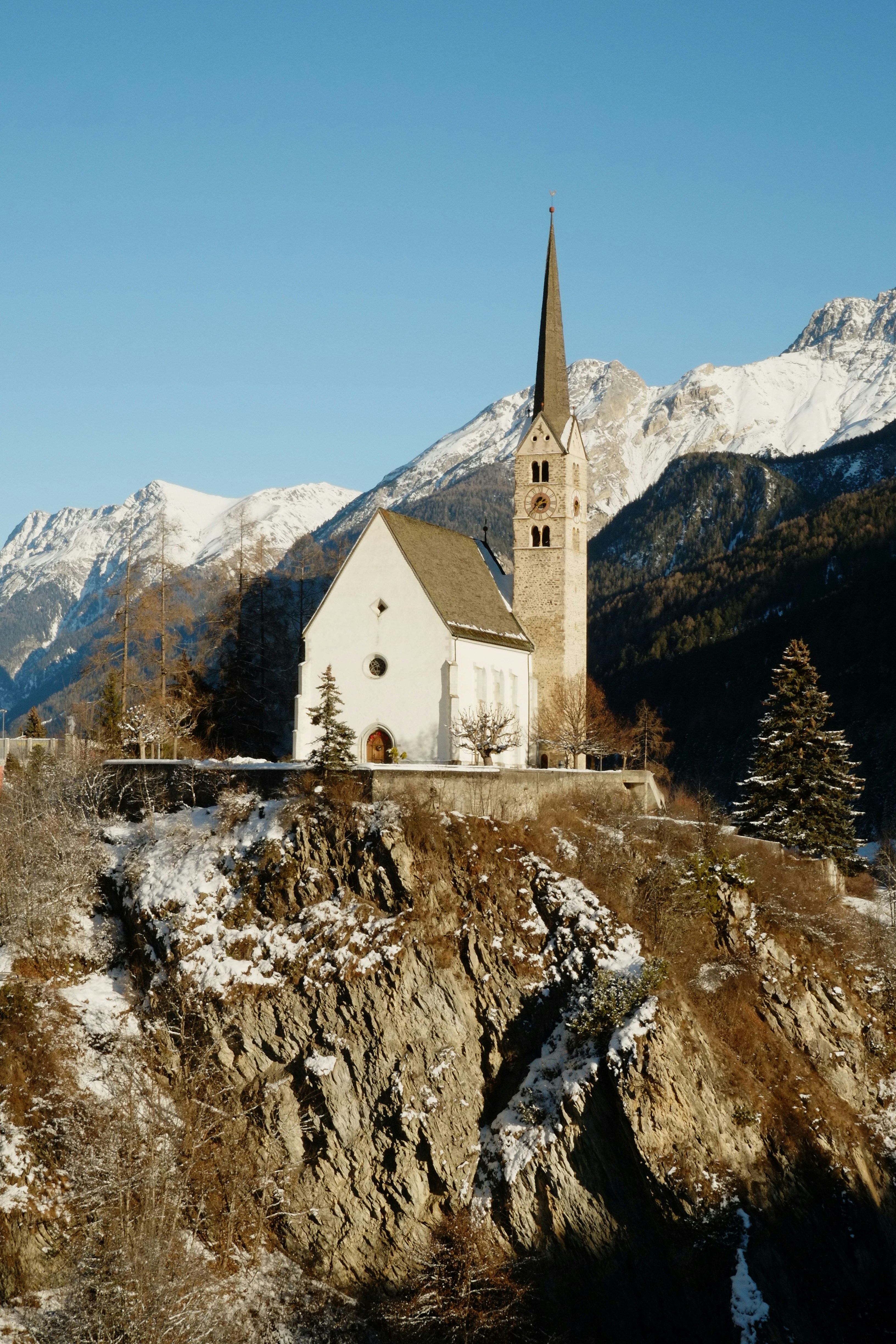A church on top of a cliff with a mountain in the background photo ...