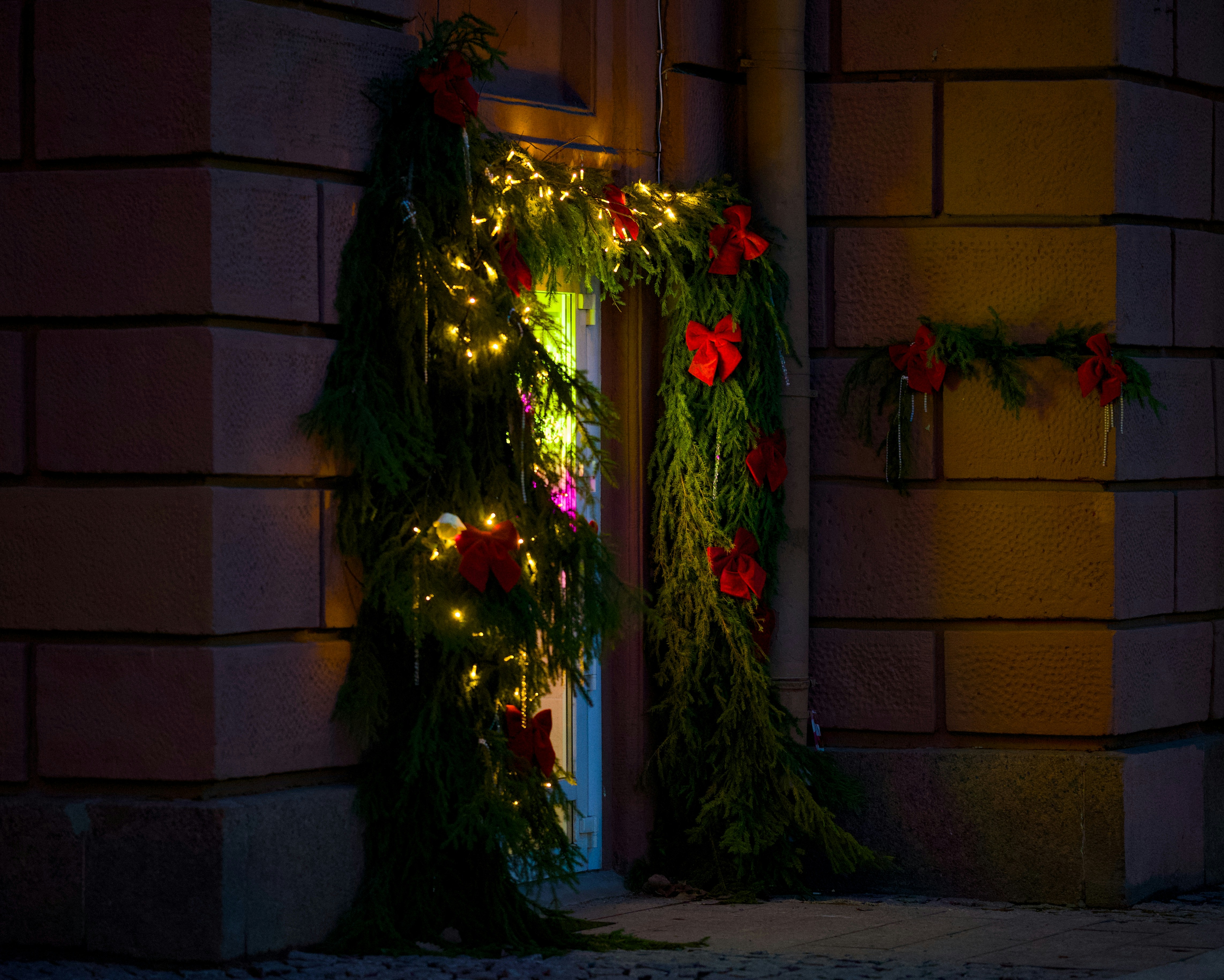 Doorway Framed by Festive Garland and Golden Lights in Nightfall