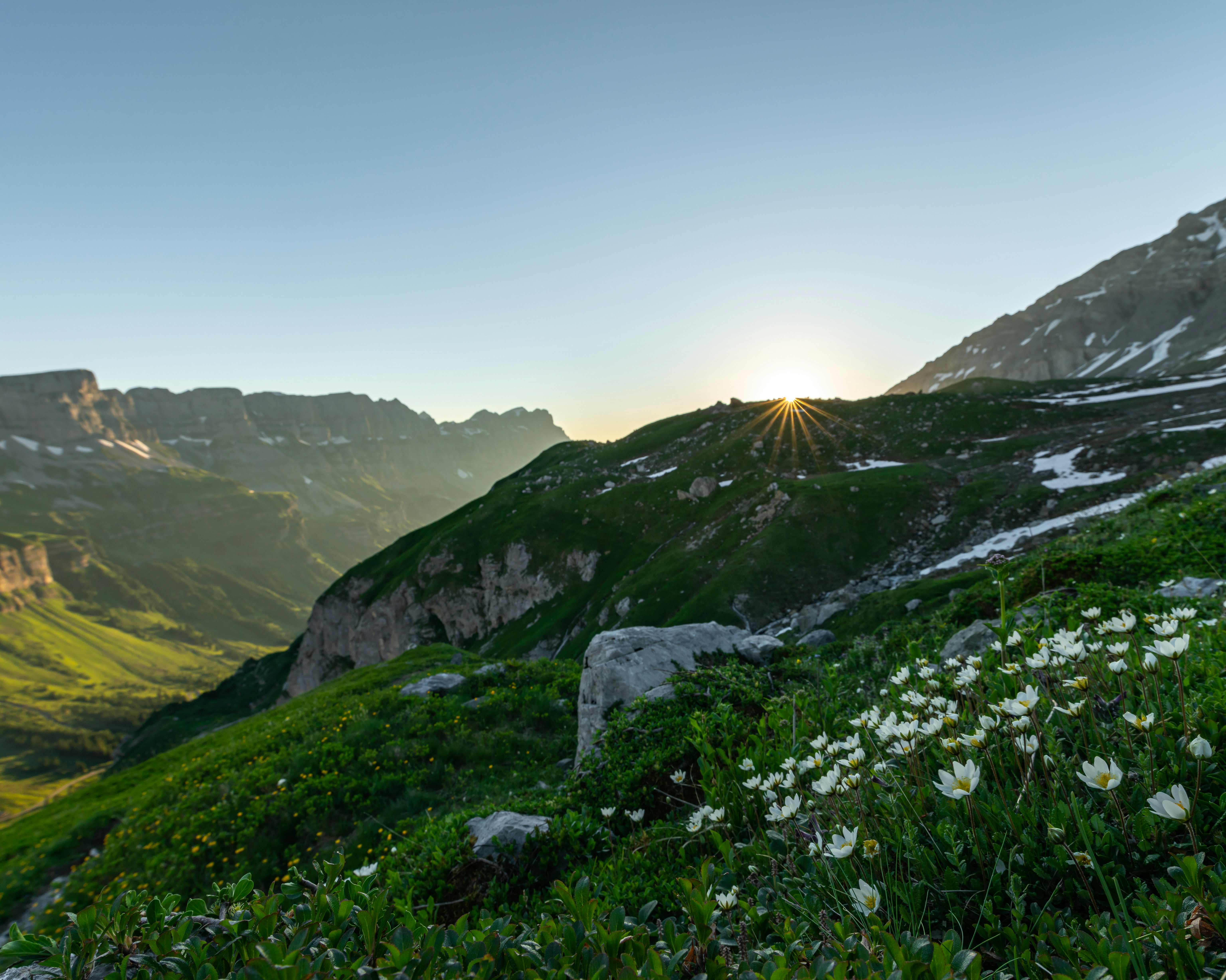 The sun is setting over the mountains in the valley photo – Free ...