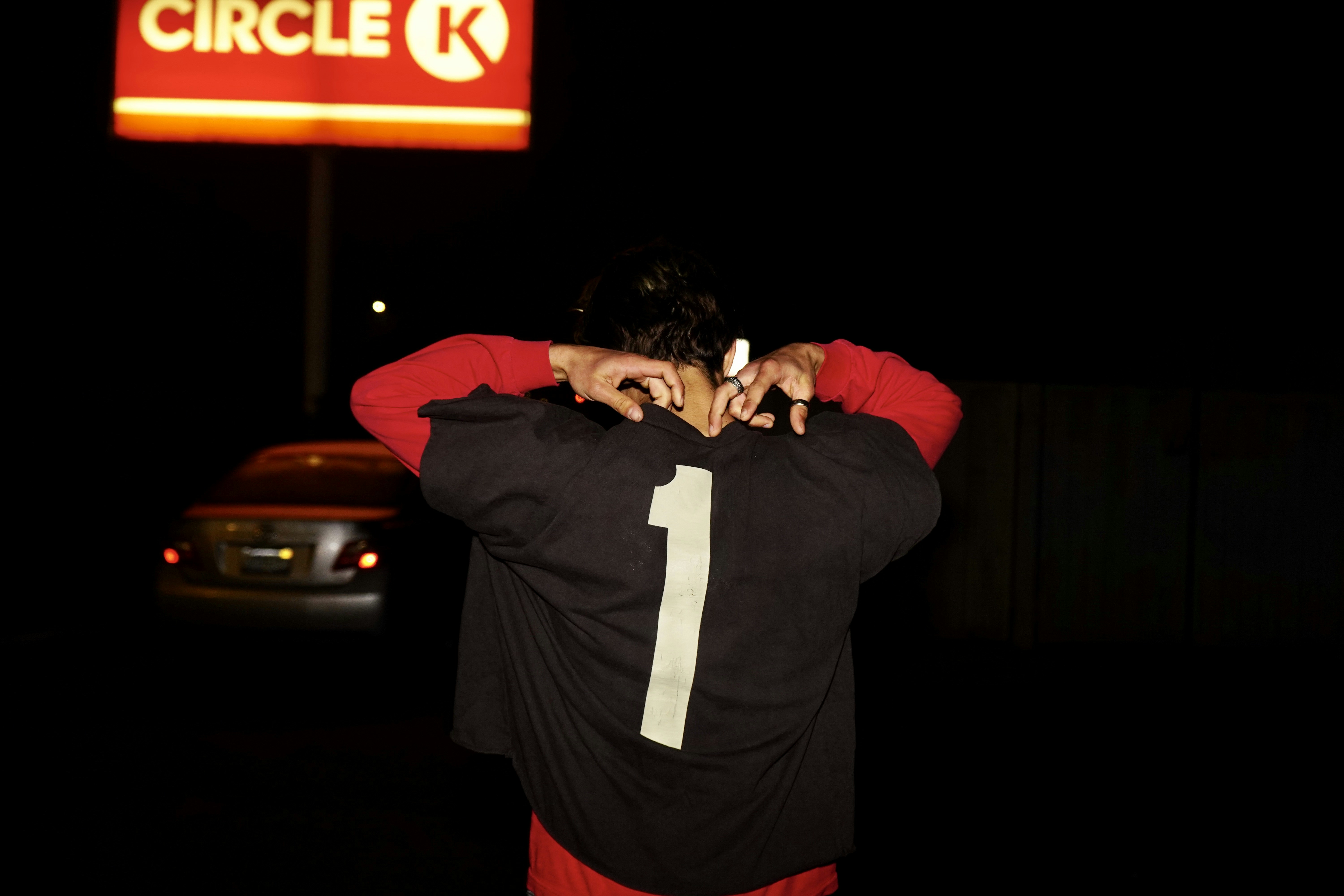 A person standing in front of a circle k sign photo – Free Portrait ...