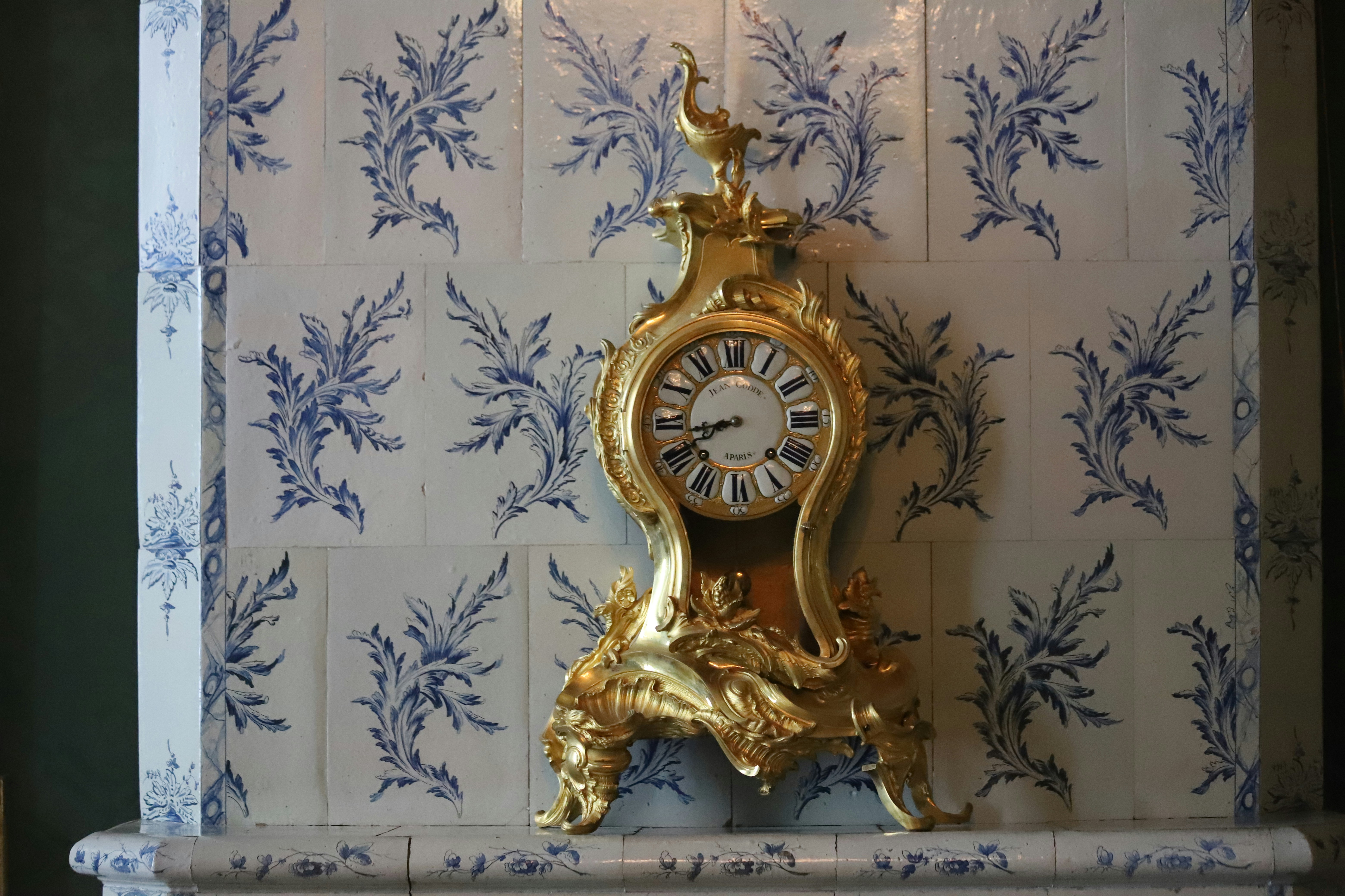 Gilded Baroque Timepiece Framed by Delft-Blue Florals