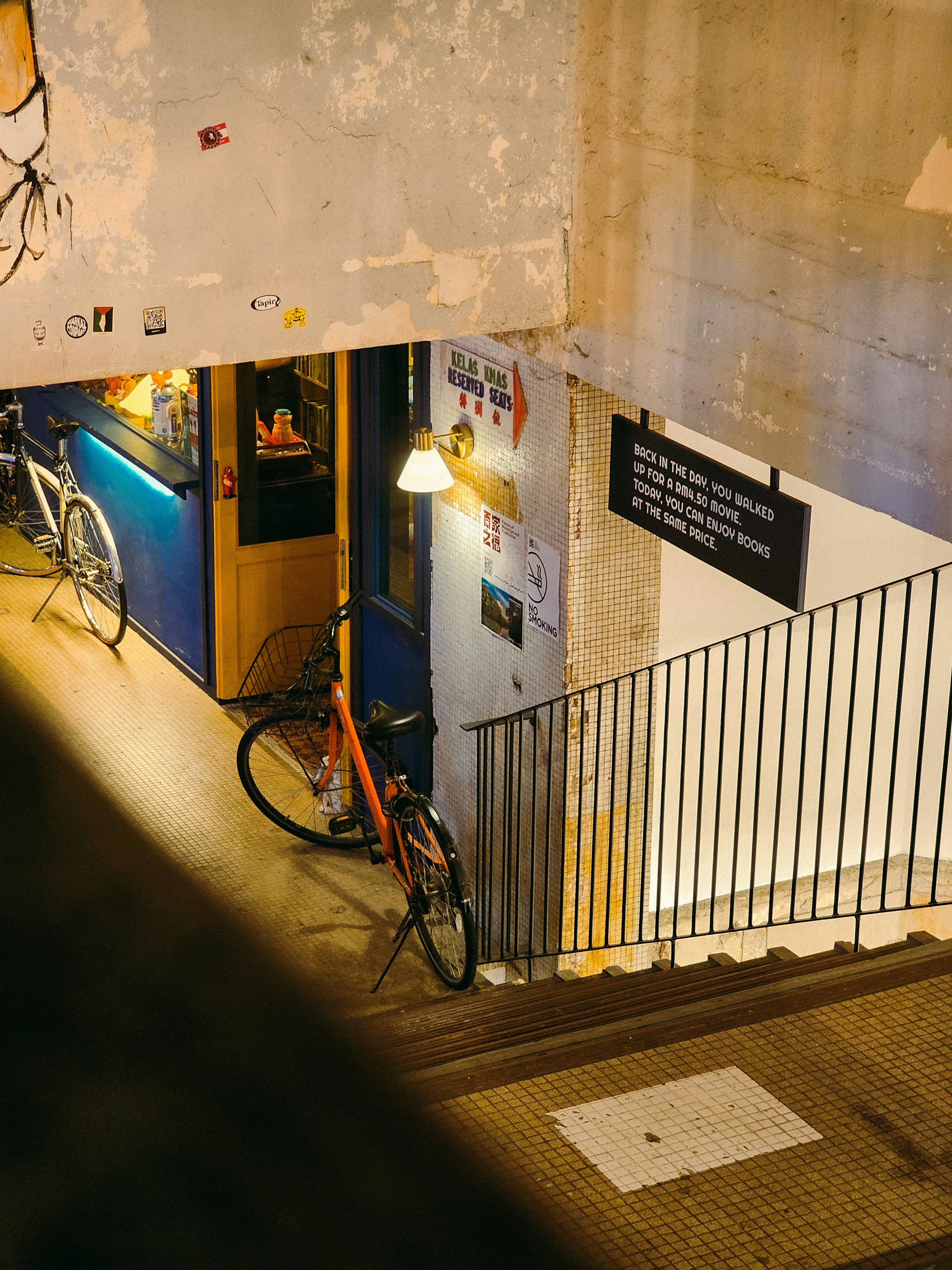 Stairwell Rendezvous: An Orange Bike Guarding a Hidden Café