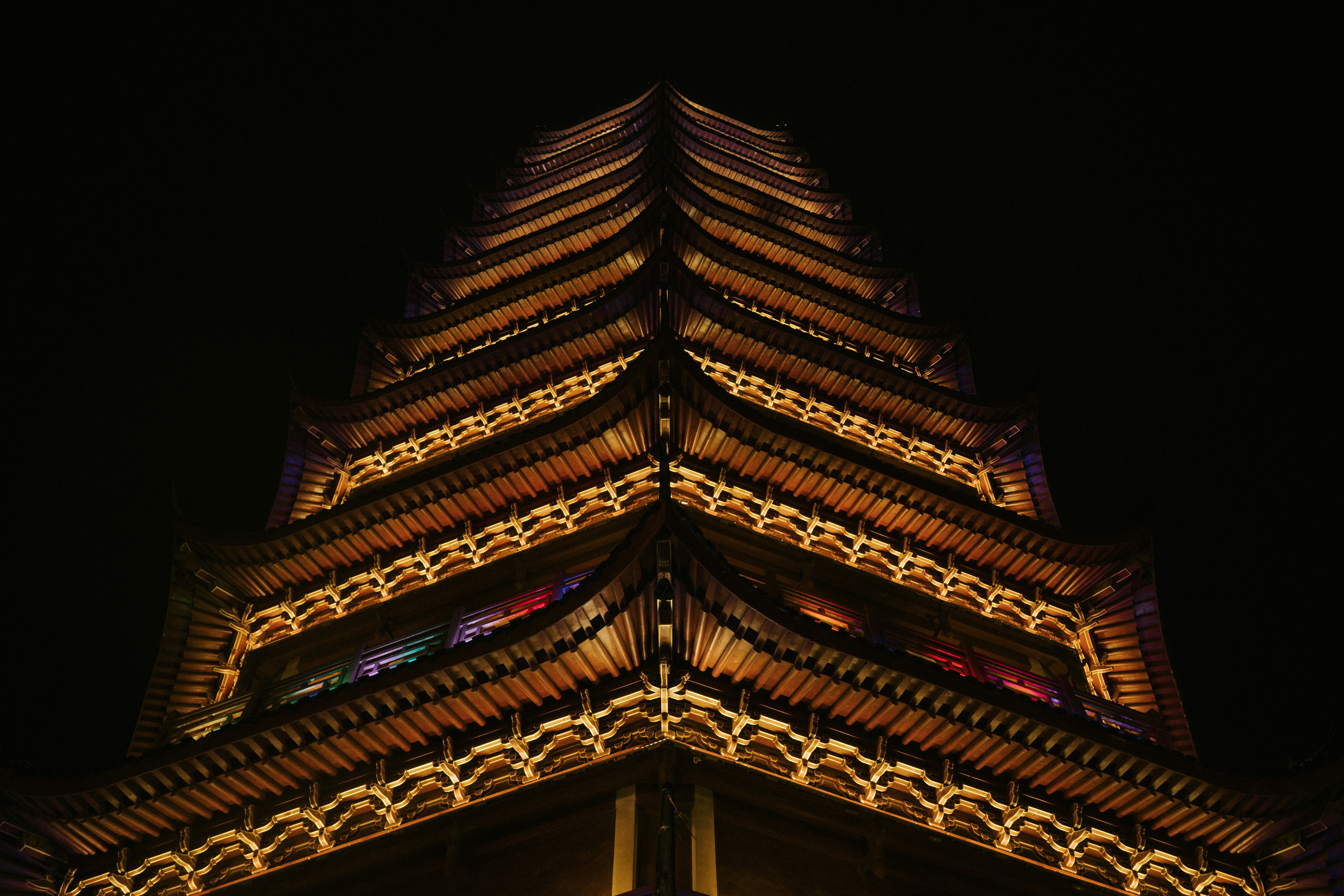 A tall tower lit up at night time photo – Free Building Image on Unsplash
