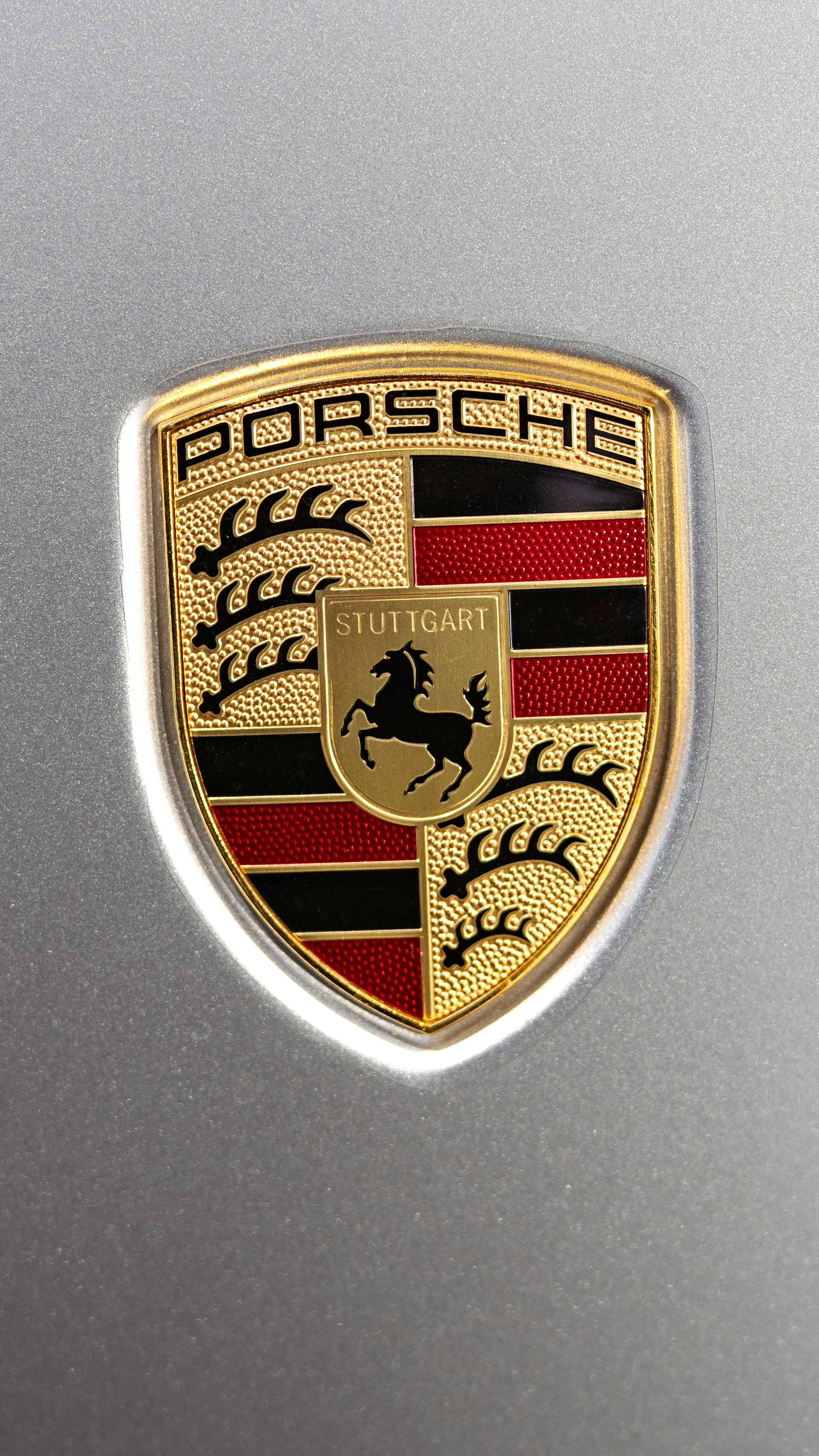 Gold Crest in Silver: A Porsche Emblem Close-Up