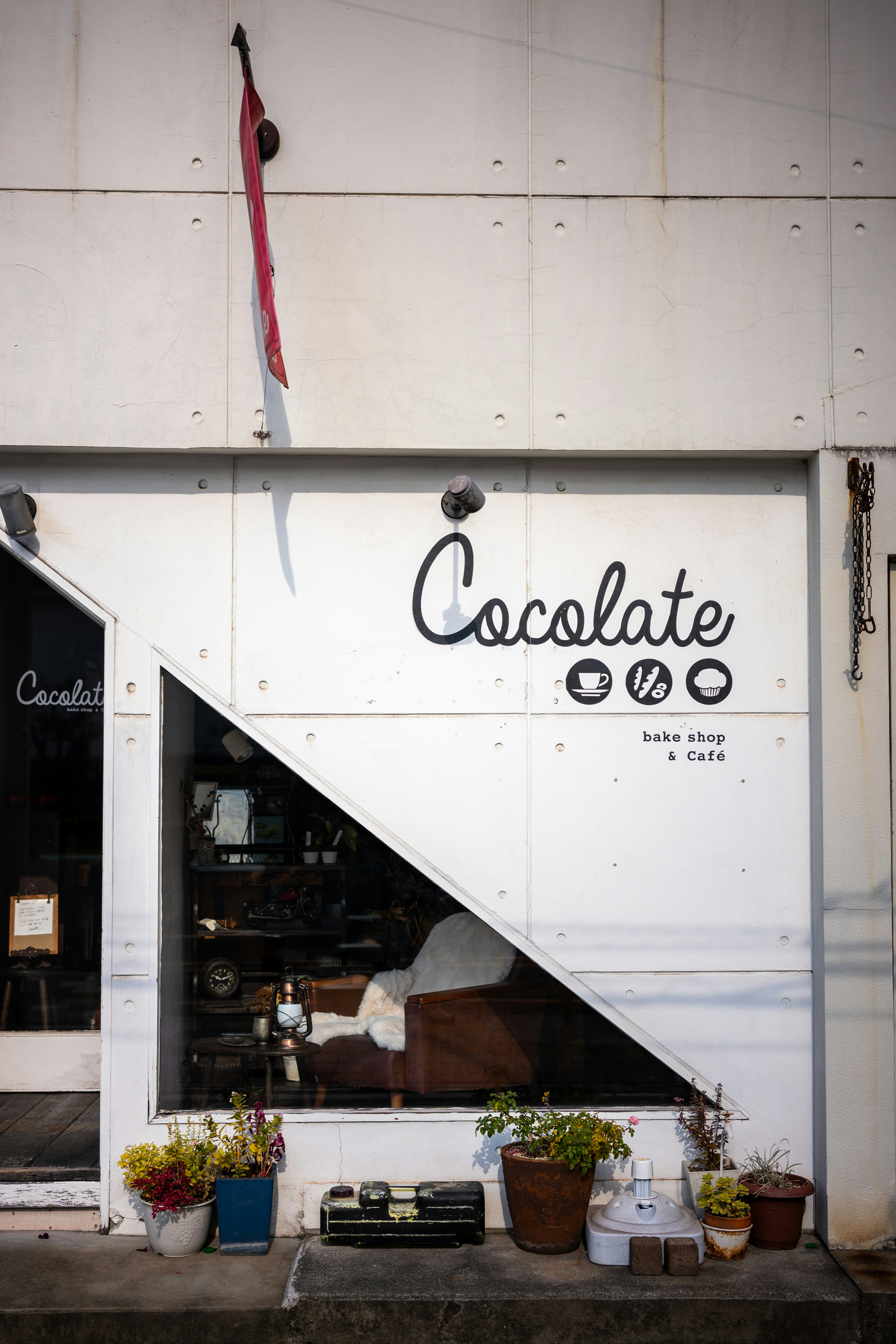 A white building with a sign that says chocolate on it photo – Free ...