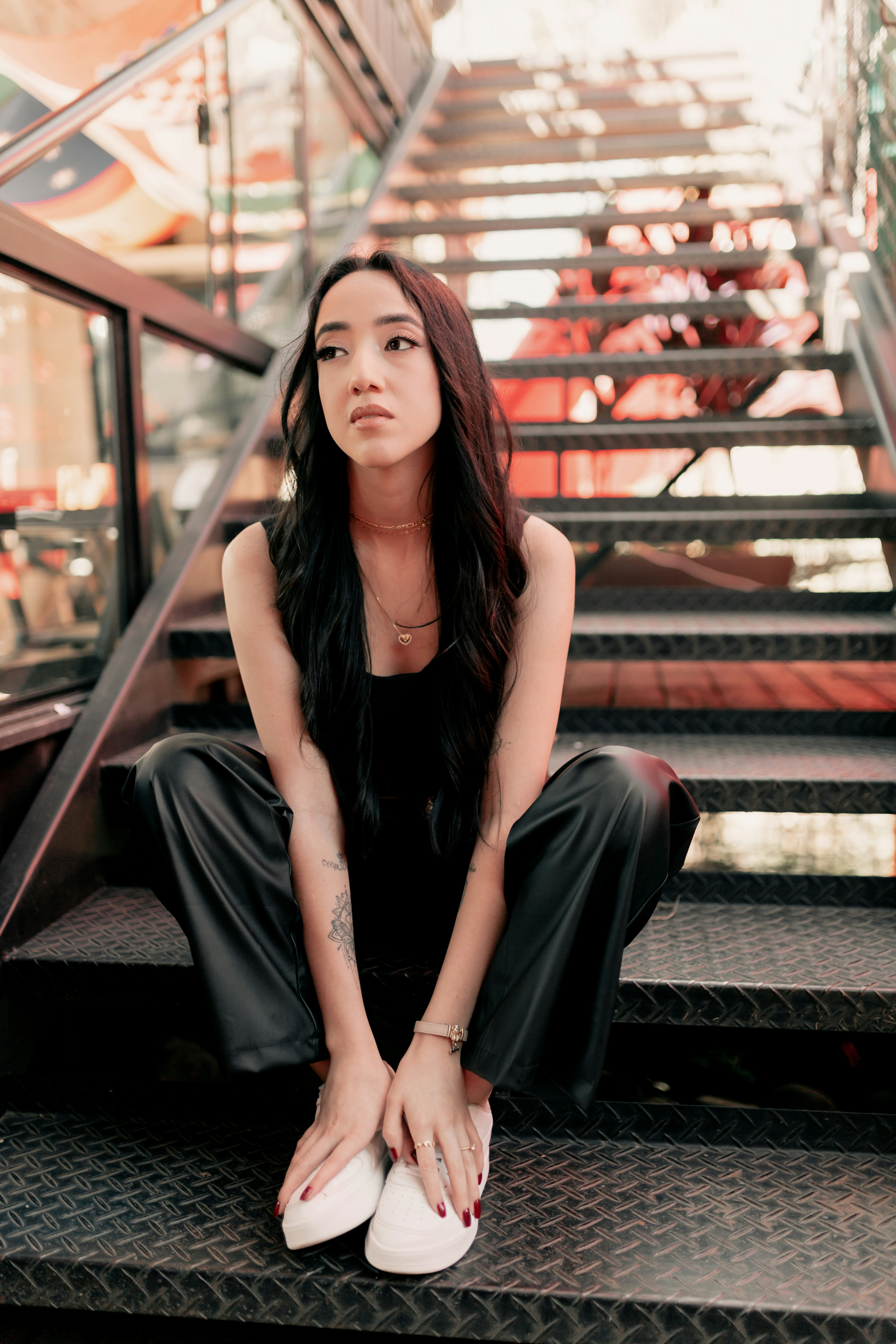 A woman sitting on the steps of an escalator photo – Free Human Image ...