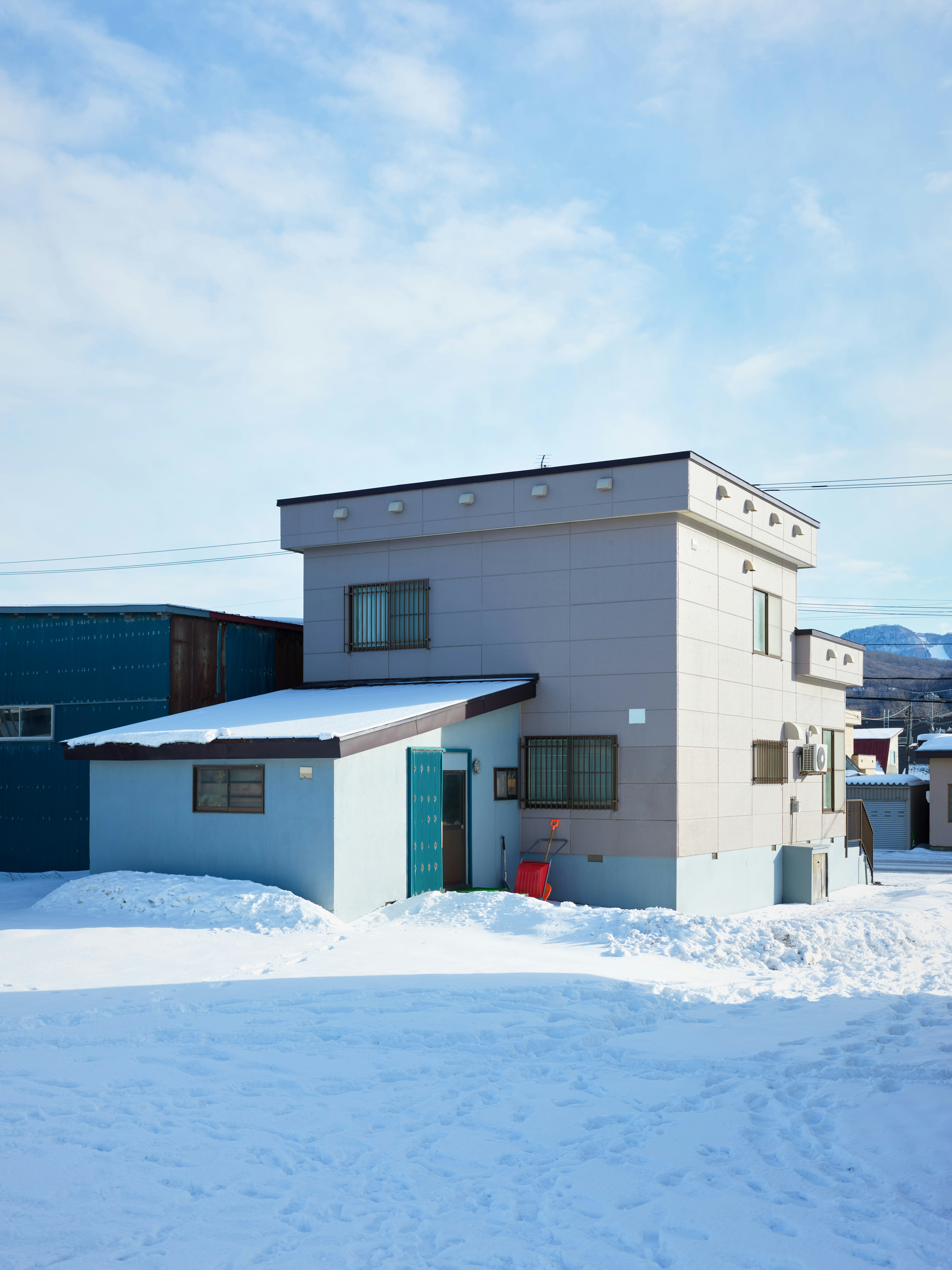 Turquoise Door in a Snowbound Modern Block