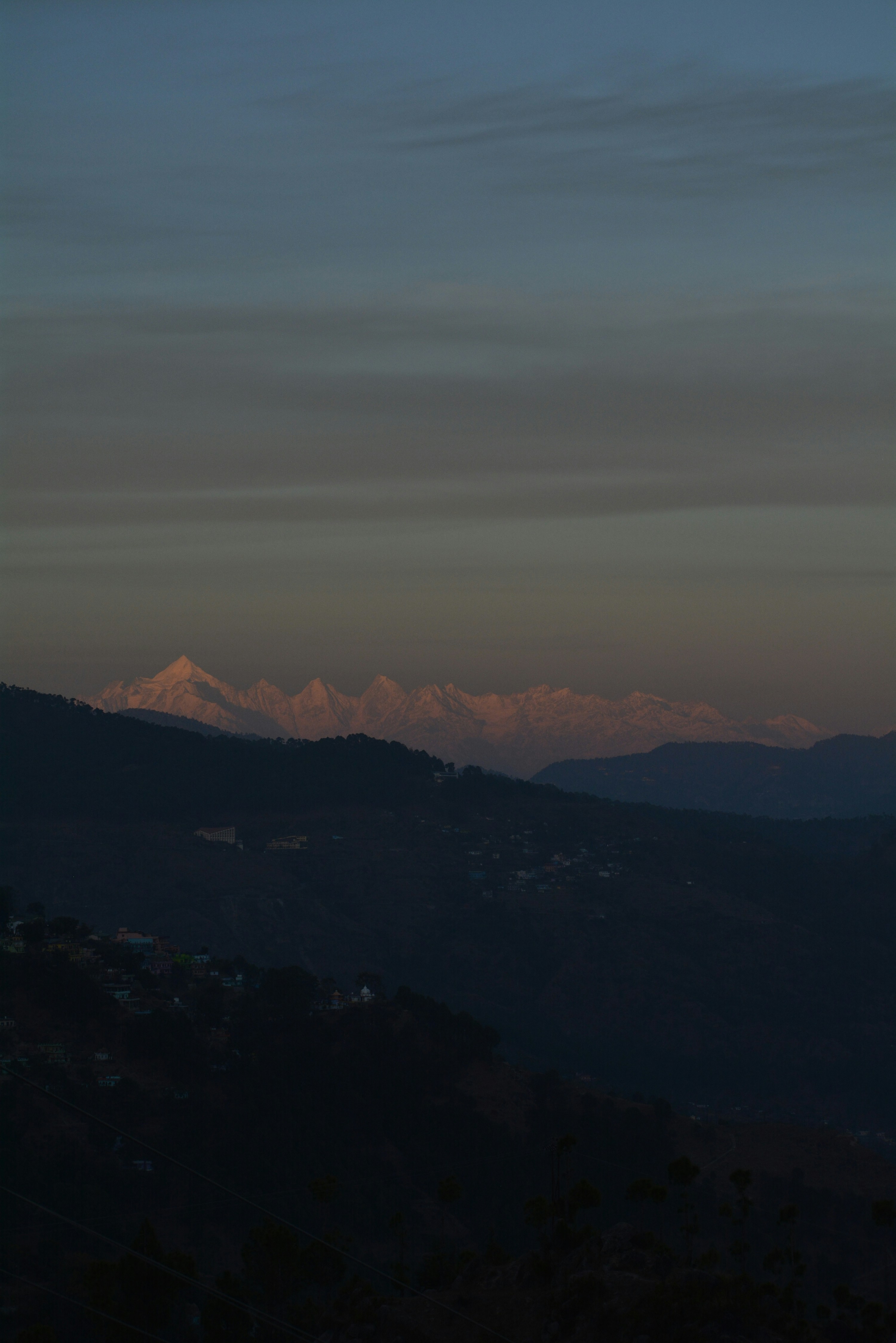 Alpenglow Ridge: Snow-Capped Peaks Rise Over a Quiet Valley at Dusk