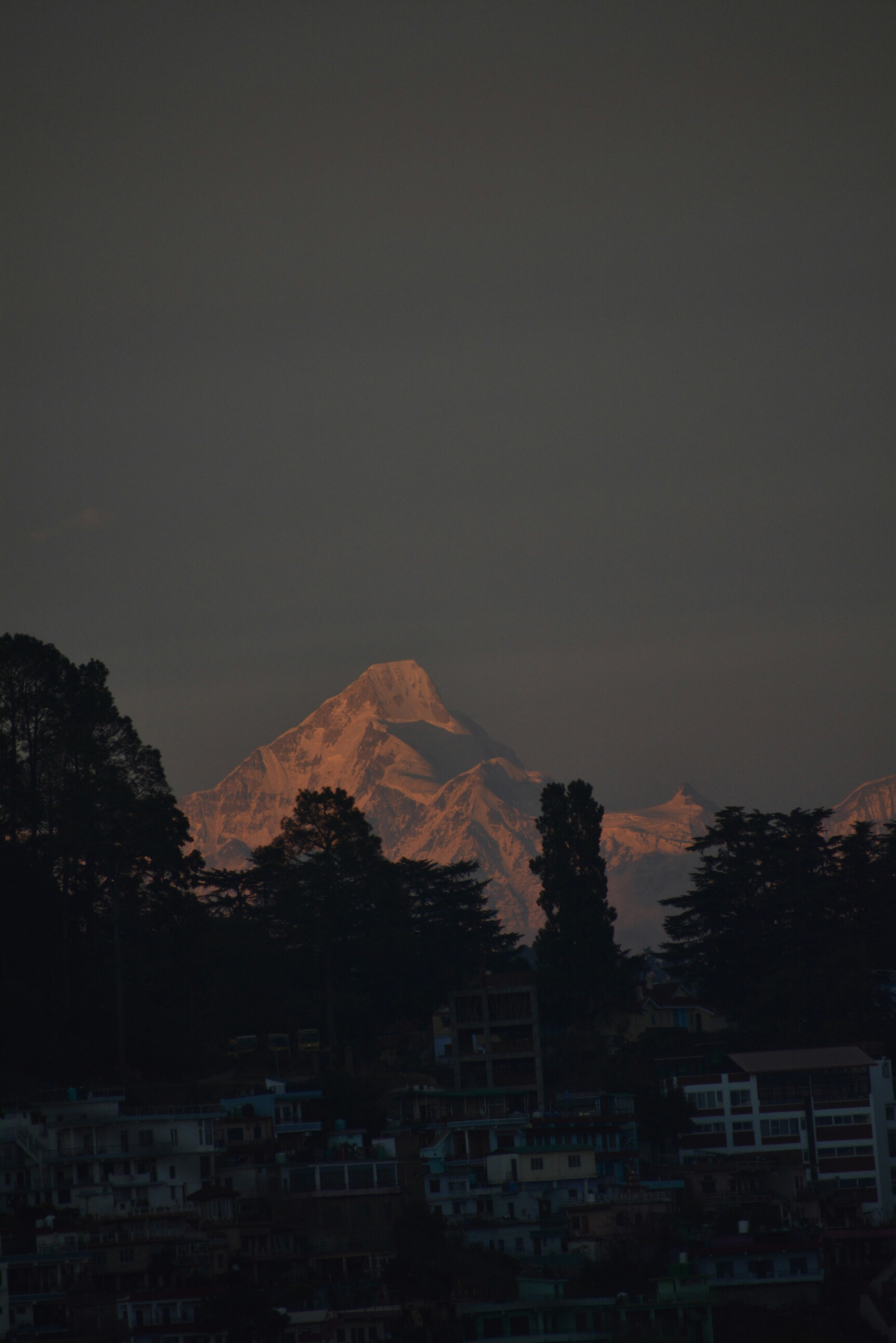 Alpenglow Crowned Peak Over a Sleeping Town