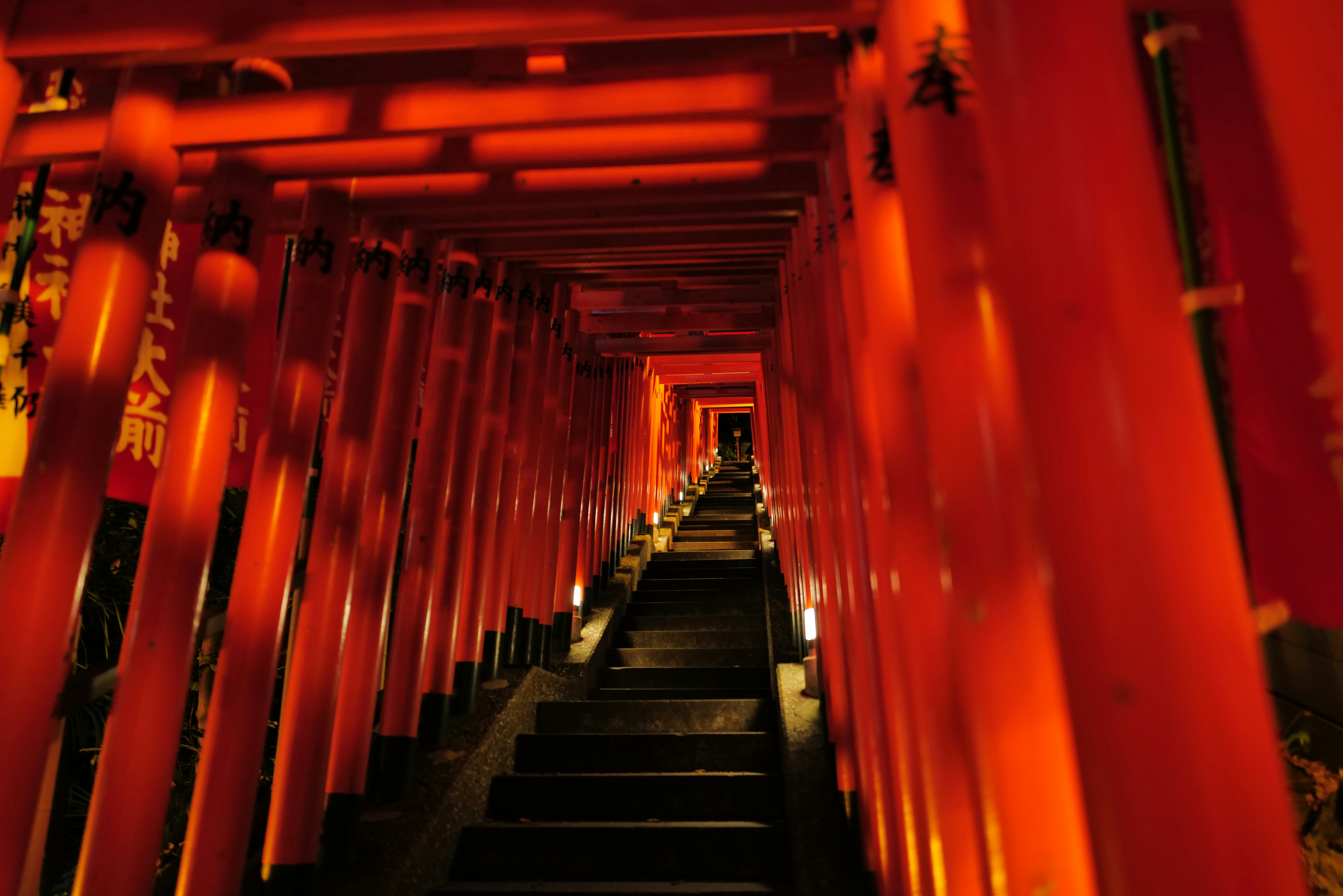 A long row of red pillars with lights on them photo – Free Building ...