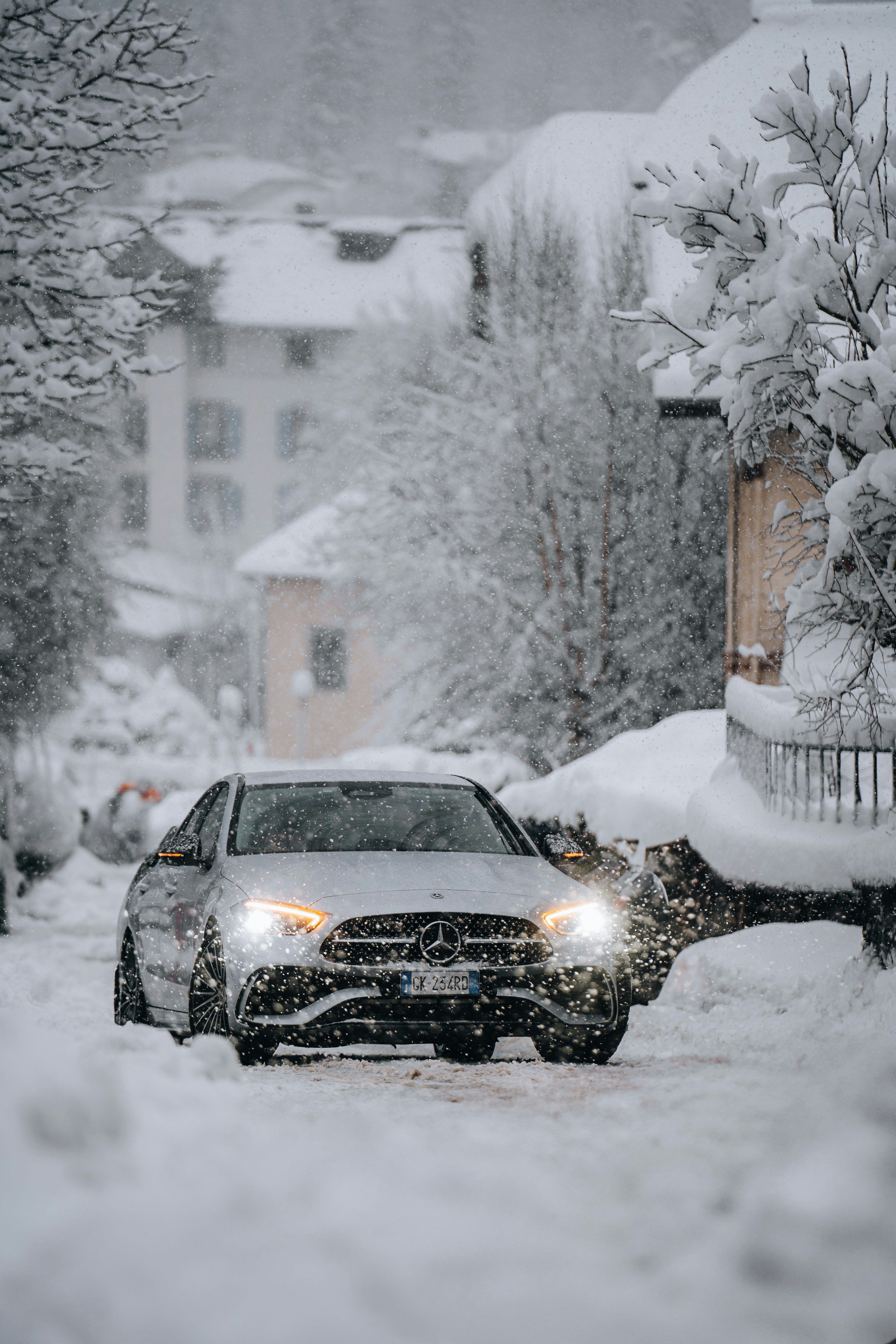 A car driving down a snow covered street photo – Free Car Image on Unsplash