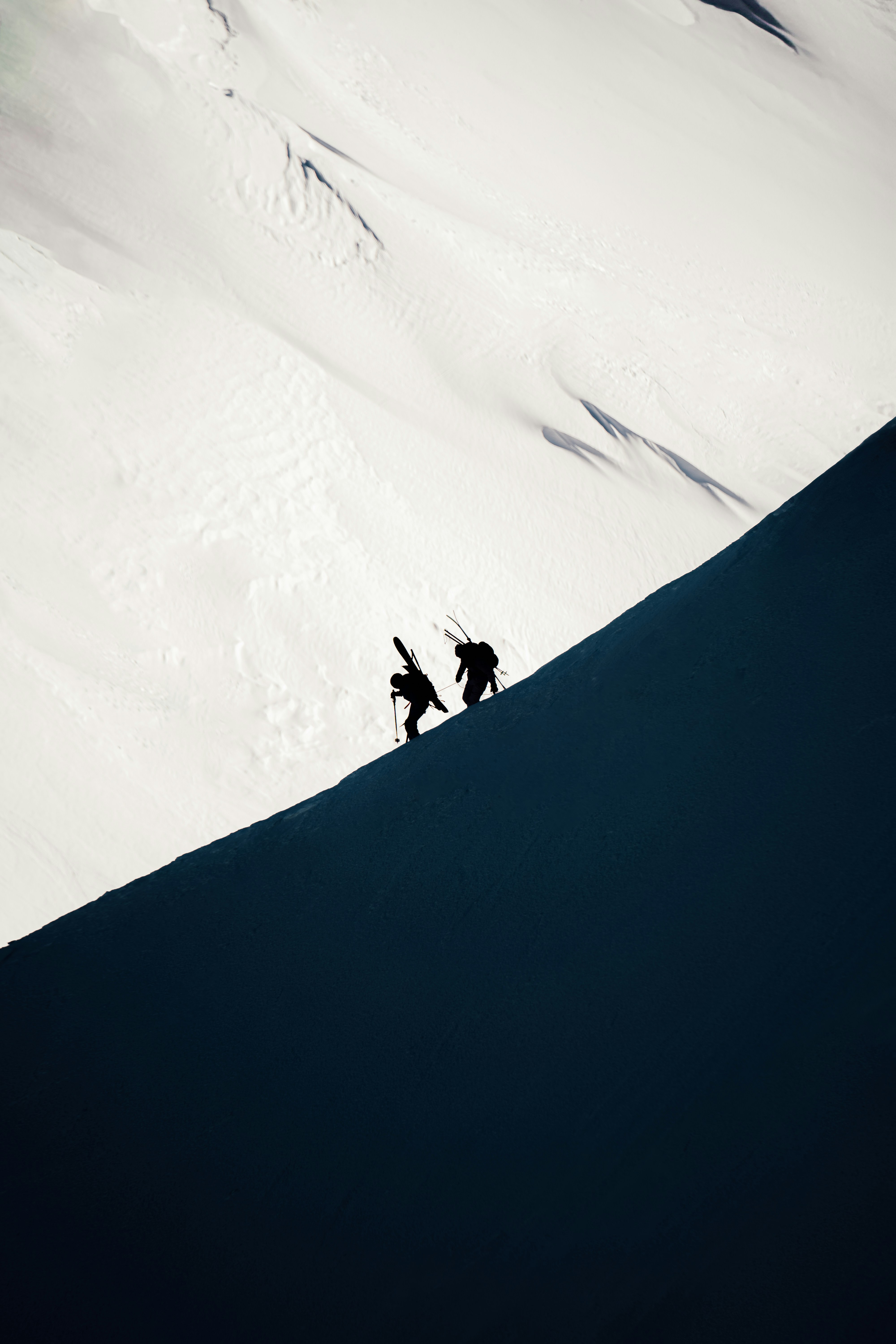 A couple of people that are standing in the snow