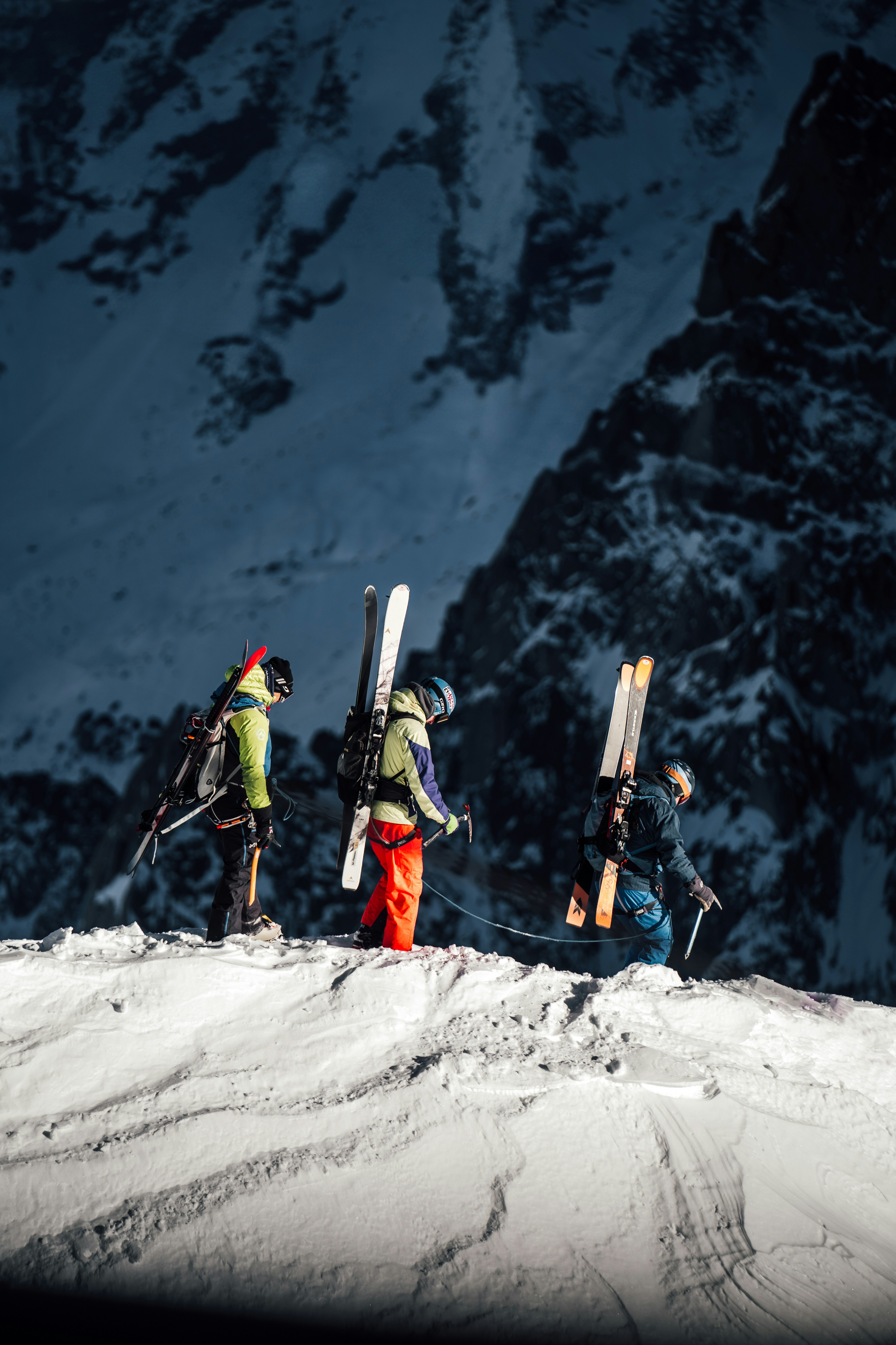 A group of people standing on top of a snow covered slope photo – Free ...