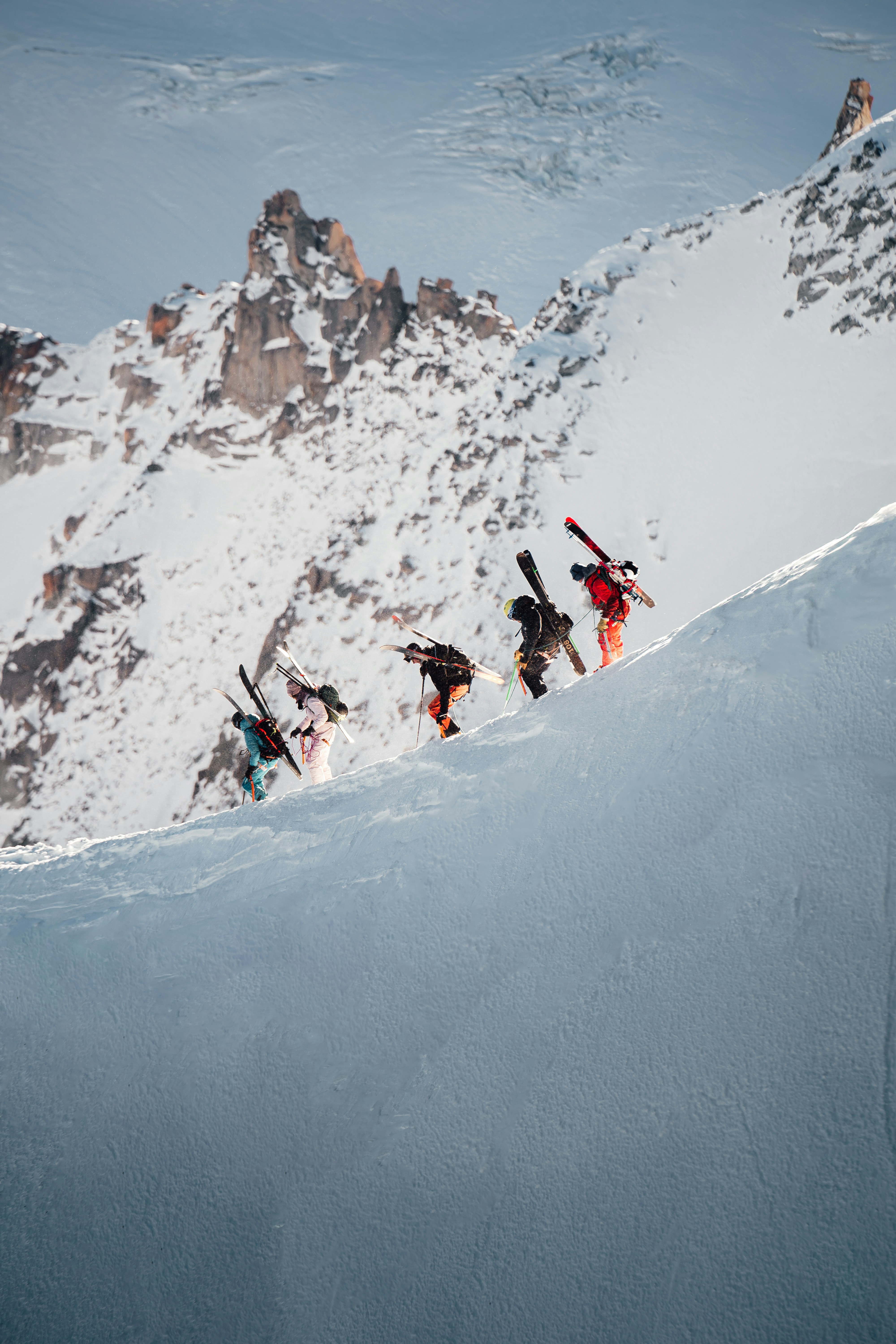 A group of people riding skis down a snow covered slope photo – Free ...