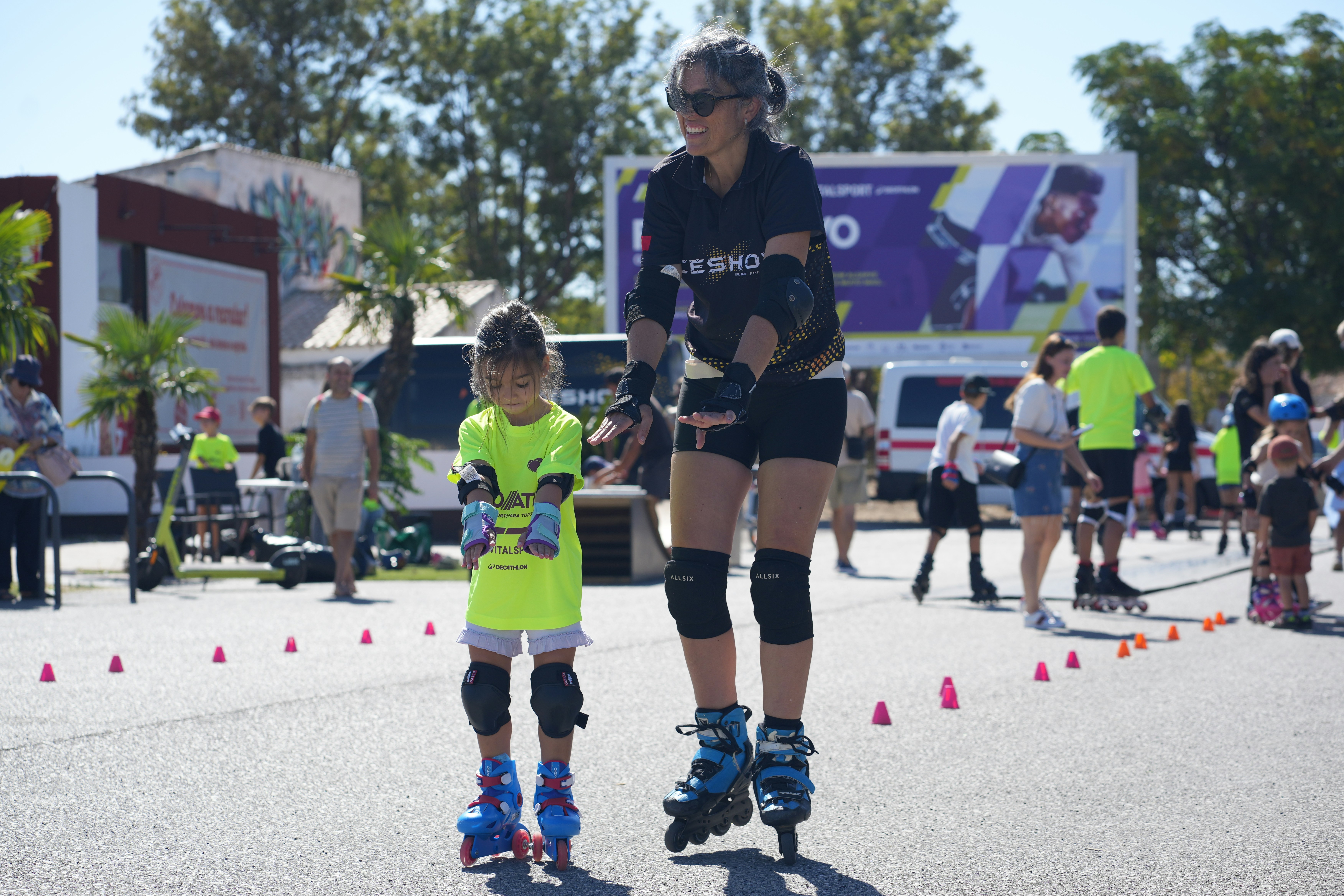A woman riding a skateboard next to a little girl on a skateboard photo ...