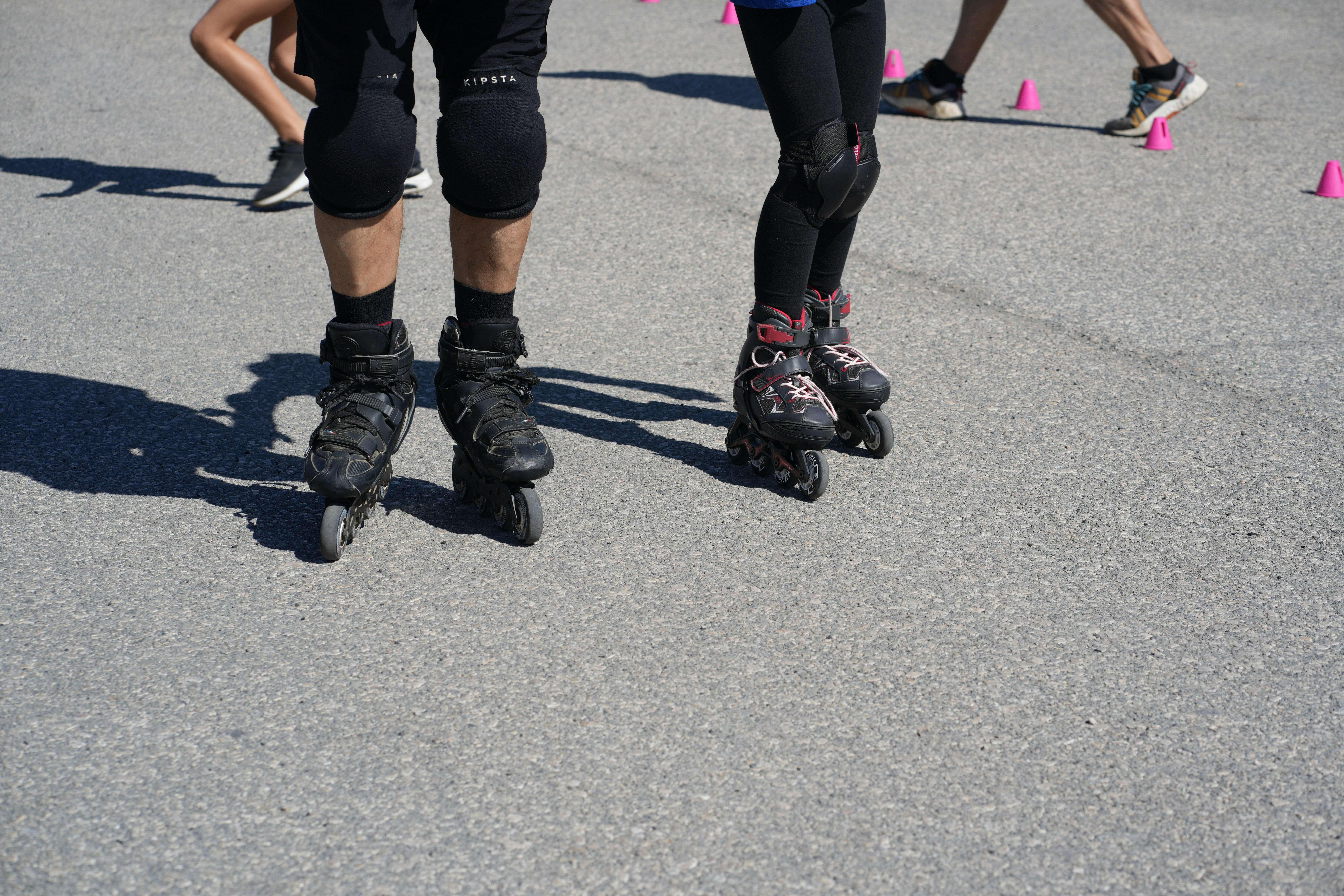 A group of people riding skateboards down a street photo – Free Skating ...