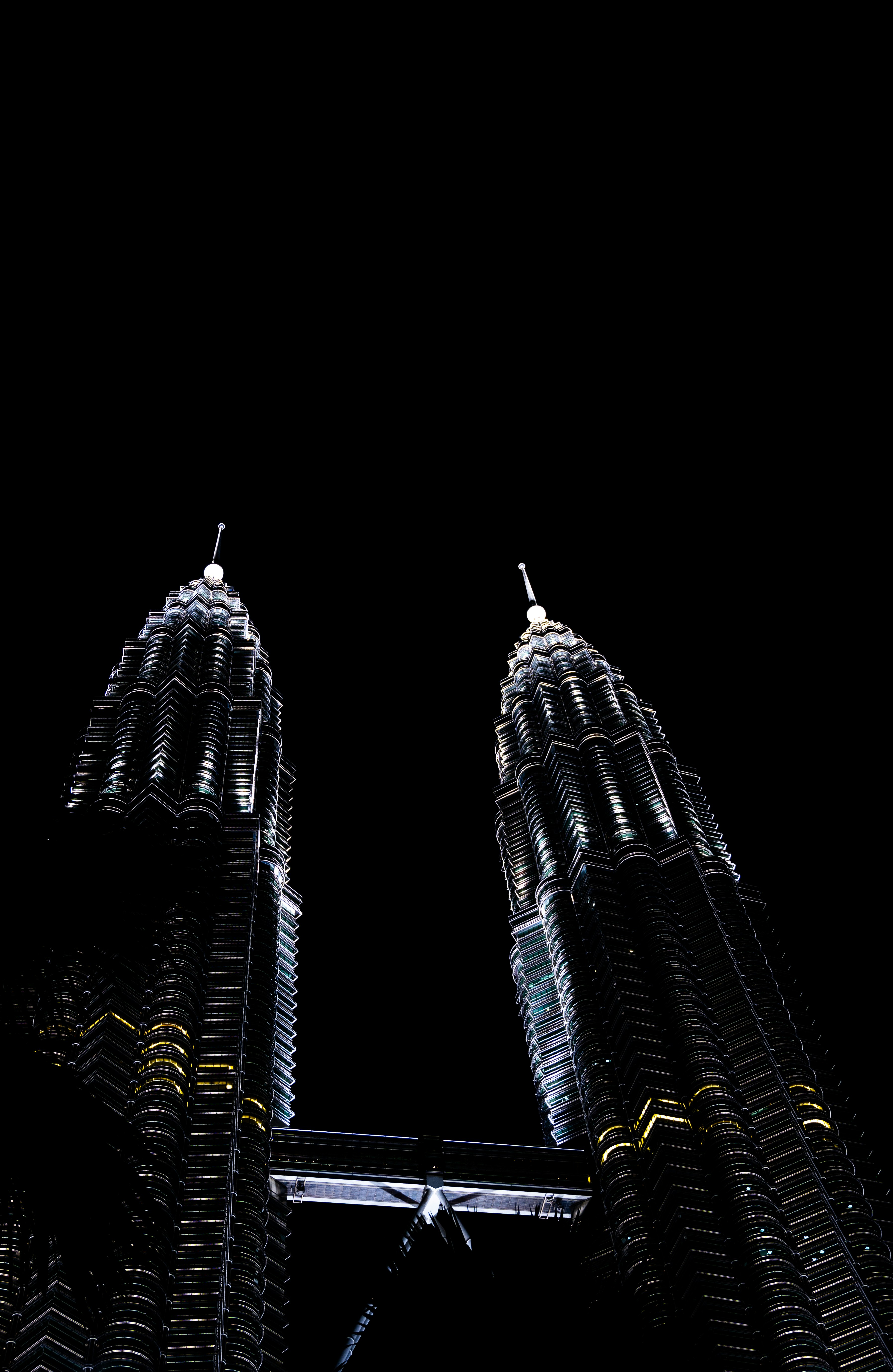 A couple of very tall buildings towering over a city photo – Free Kuala ...