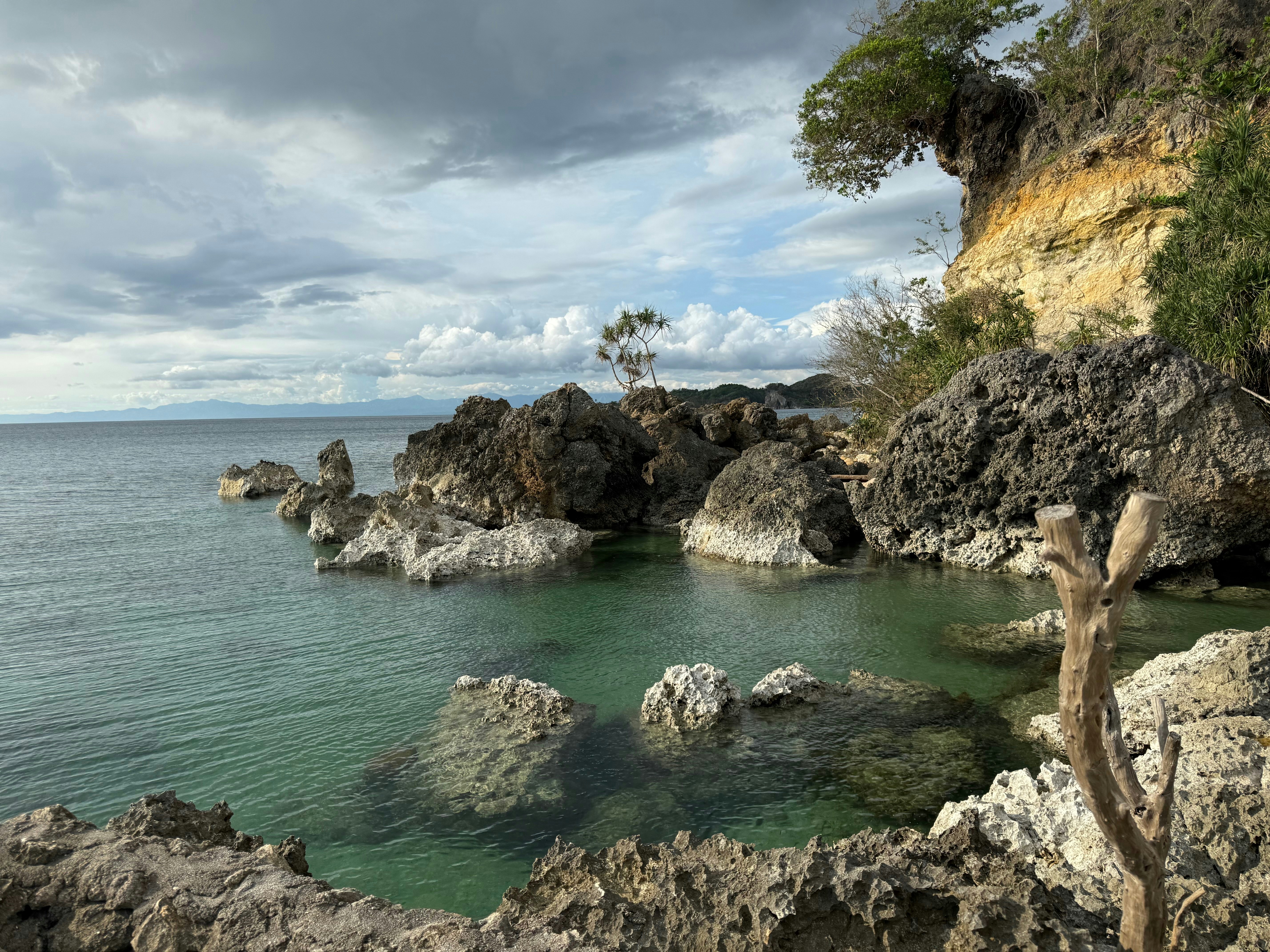 A body of water surrounded by rocks and trees photo – Free Nature's eye ...
