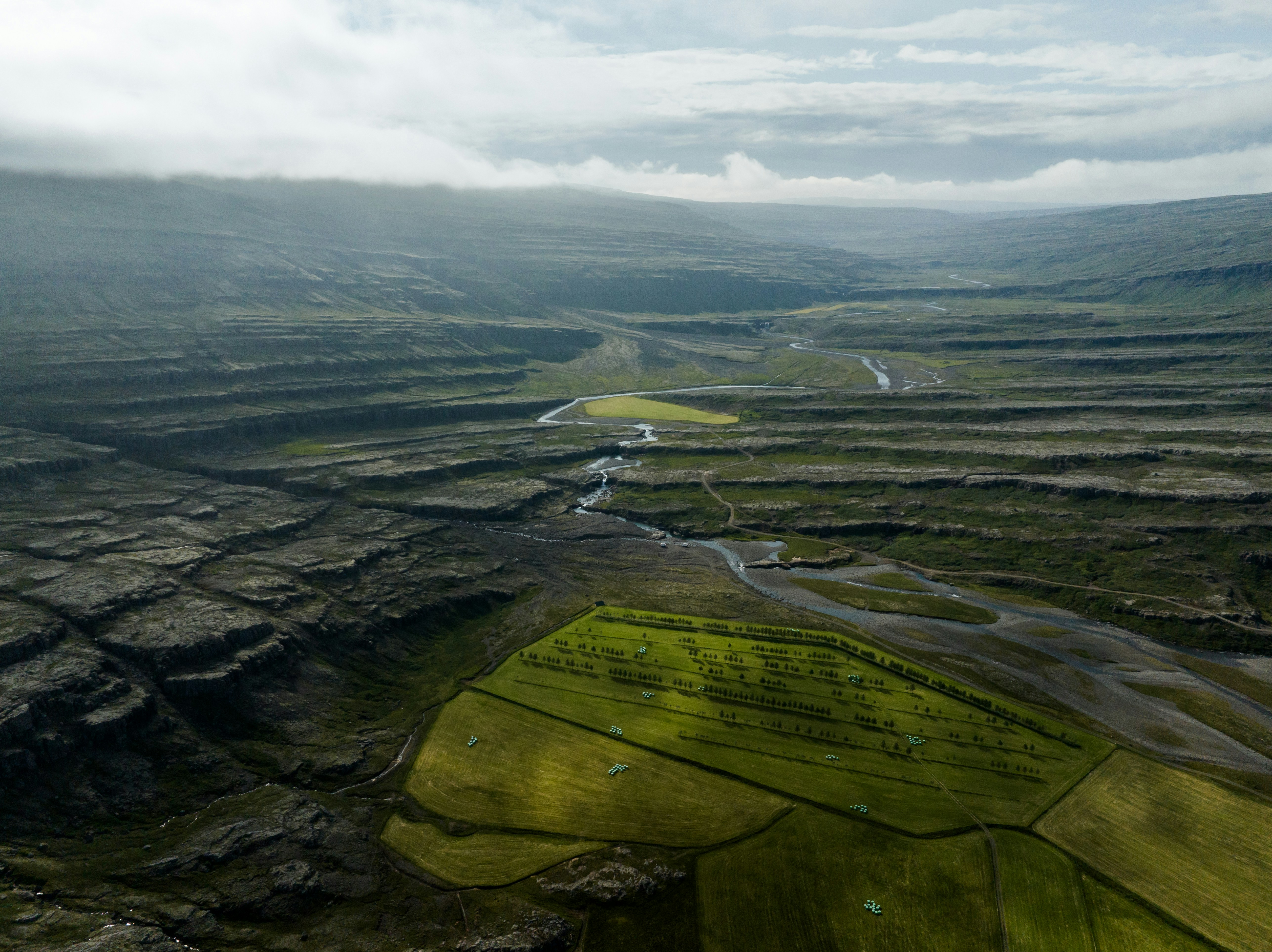 An aerial view of a valley with a river running through it photo – Free ...