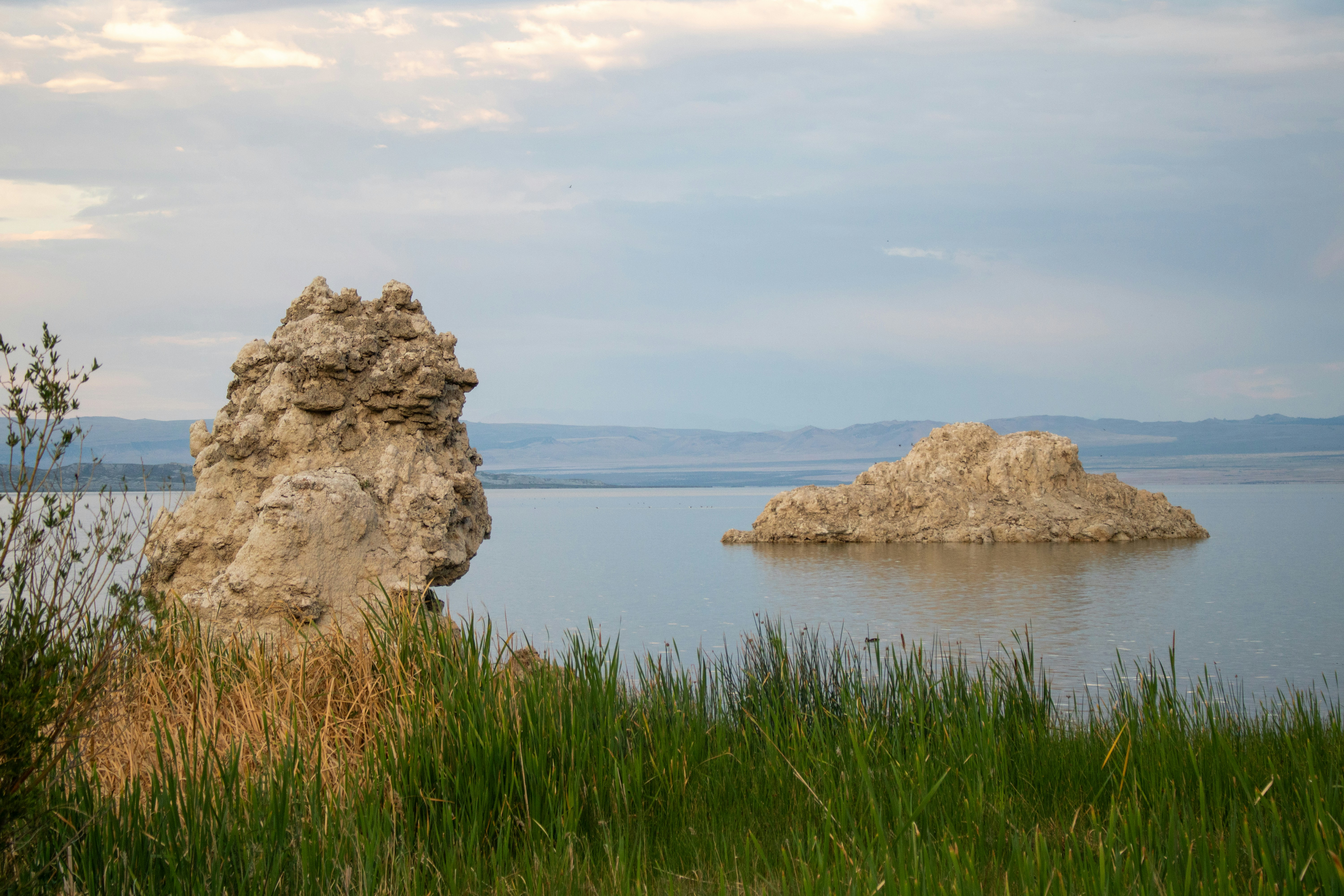 Mono Lake, located in California’s Eastern Sierra, is famous for its otherworldly tufa formations—limestone towers created by the interaction of freshwater springs and alkaline lake water. At sunset, the lake transforms into a surreal scene as the sky paints shades of blue and pink, reflecting off the calm, salty waters. Over 760,000 years old, Mono Lake is one of the oldest lakes in North America and supports a unique ecosystem, including brine shrimp and migratory birds. Its breathtaking sunsets make it a photographer’s paradise.
