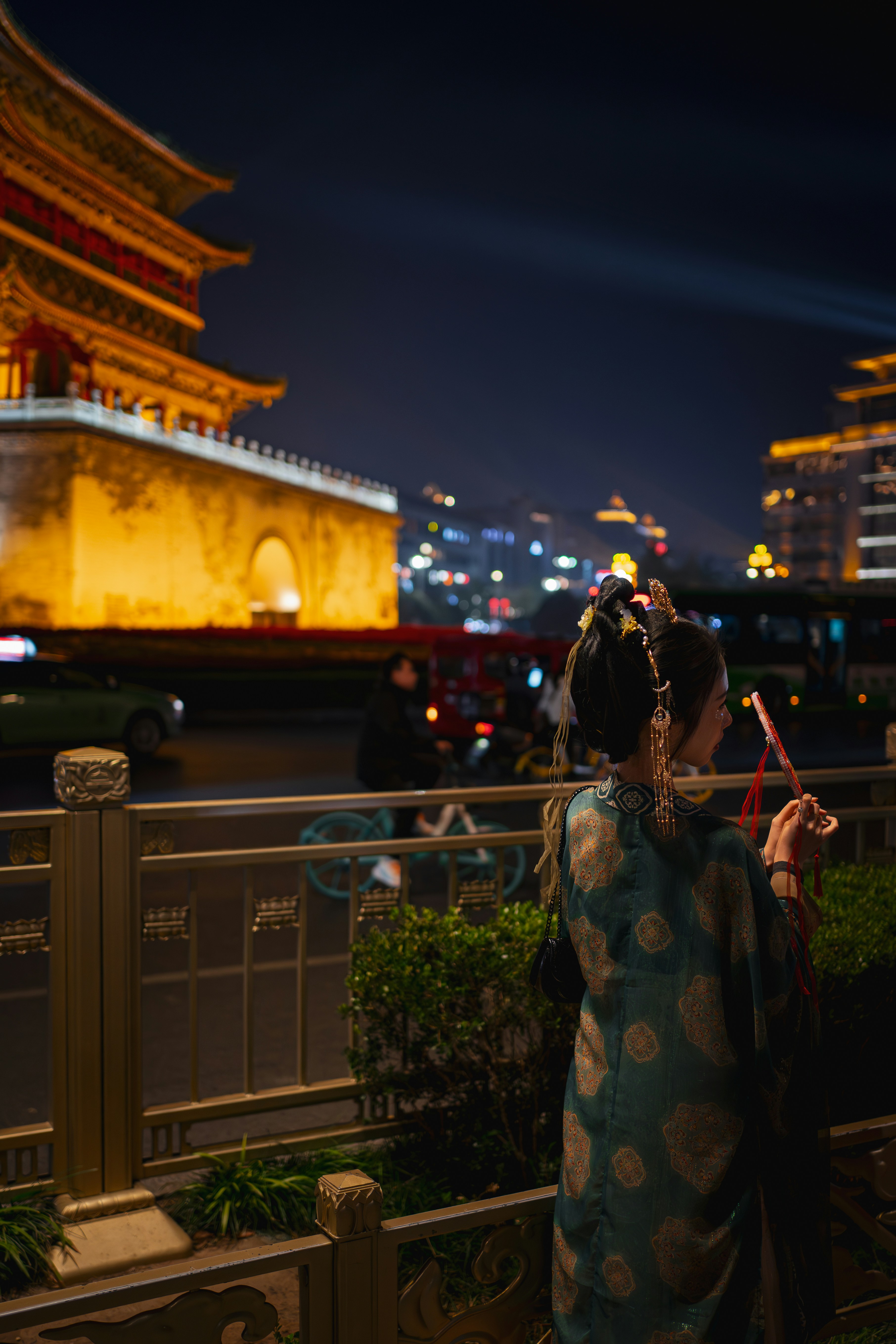 A woman in a kimono looking at the city lightsJakub Tomasik