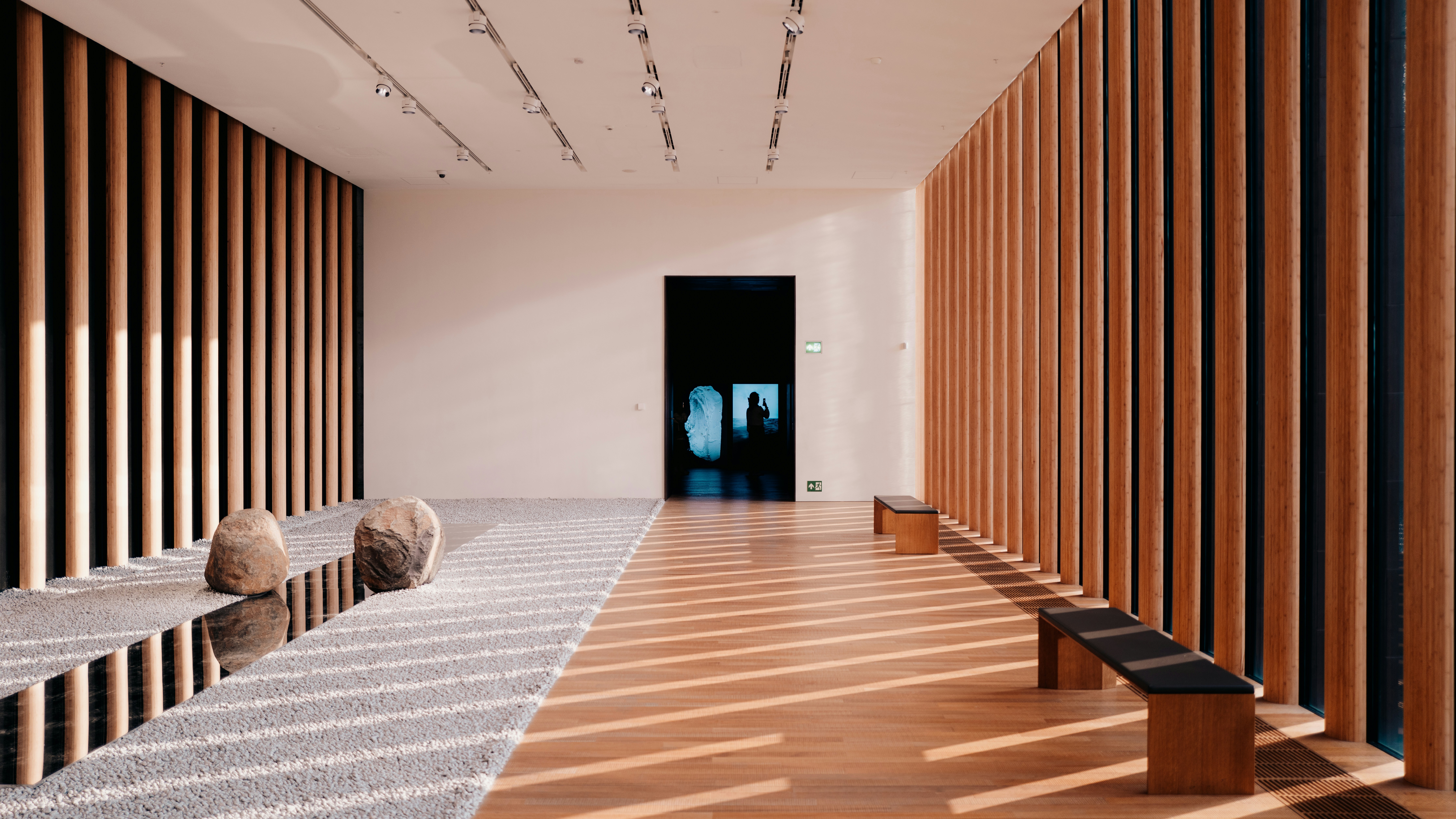End of the Corridor: Striped Light, Timber Slats, and a Neon-Glow Door