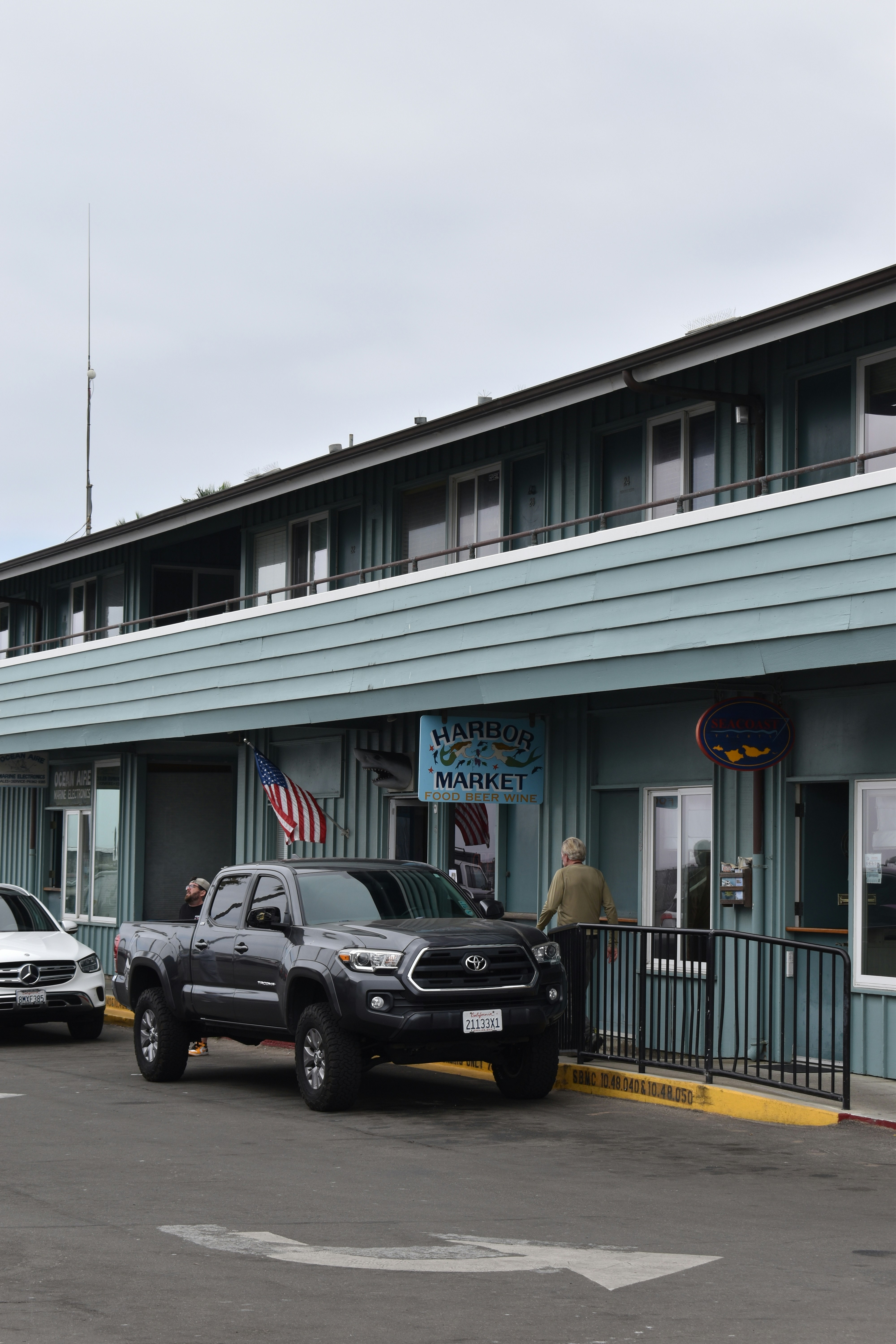 Harbor Market Facade Framed by a Sturdy Pickup and an American Flag