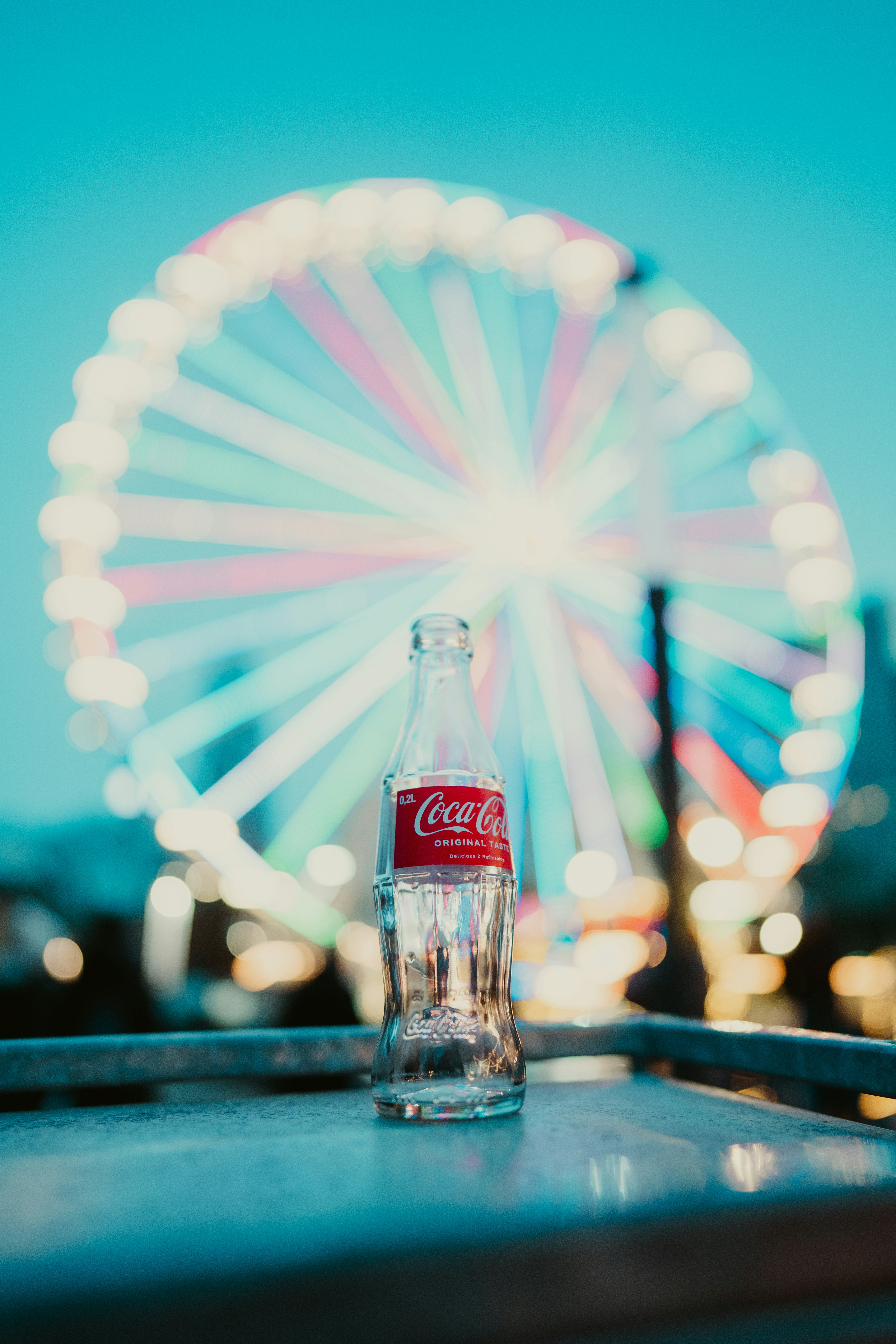 A coca cola bottle sitting on top of a table photo – Free Bottle Image ...
