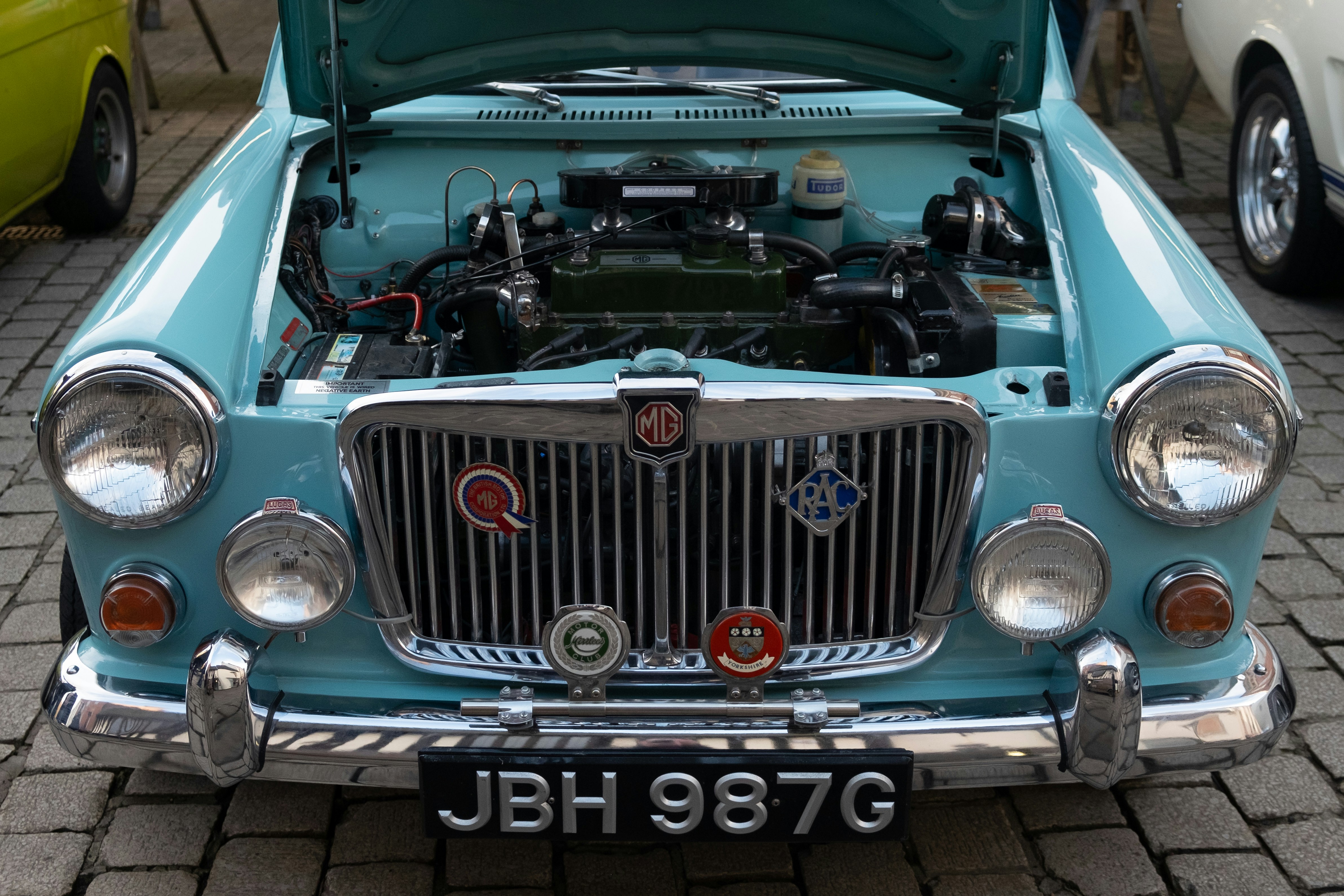 A blue car with its hood open on a brick road photo – Free Vintage car ...