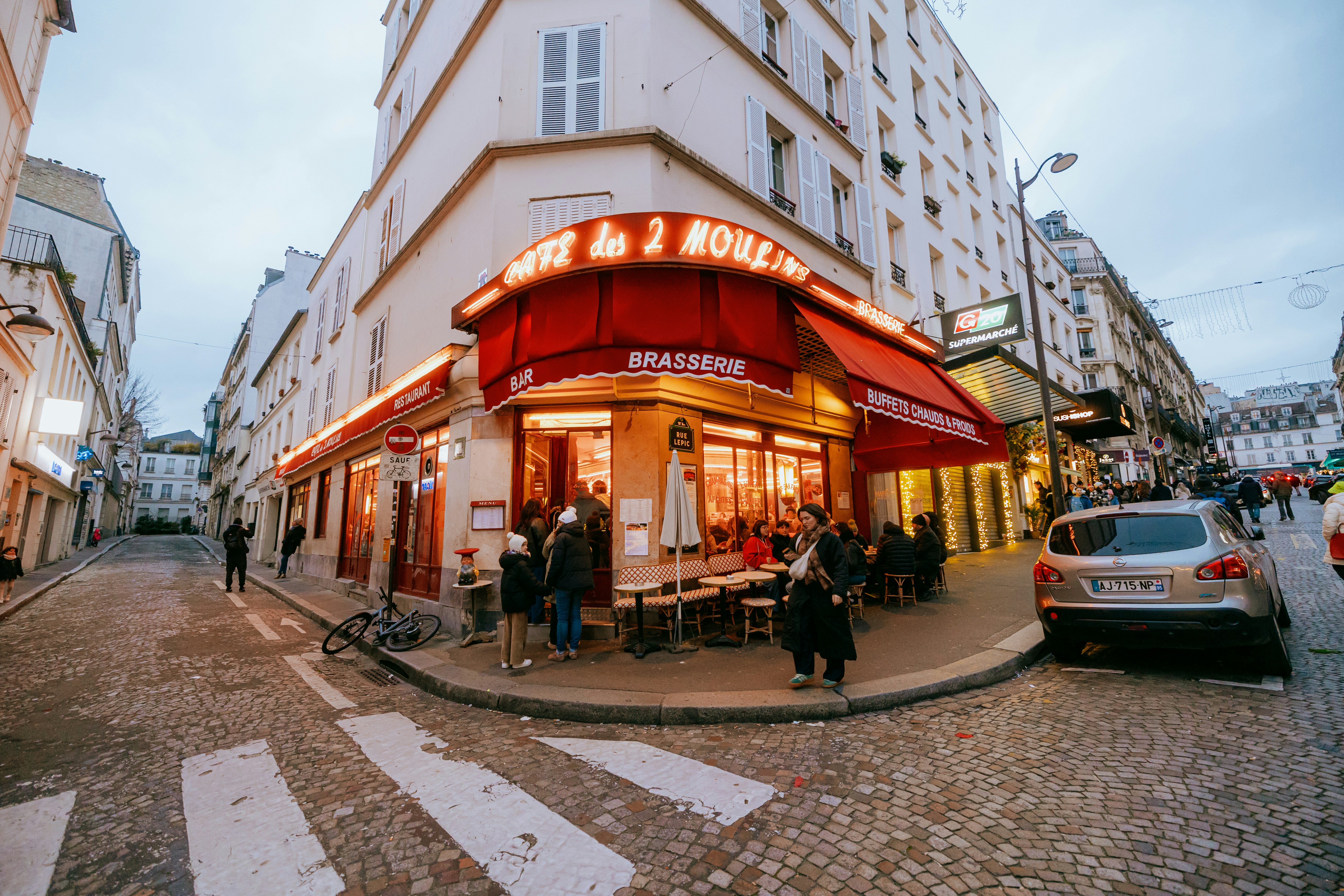 Crimson Brasserie at Dusk: Neon Warmth on a Cobblestone Corner