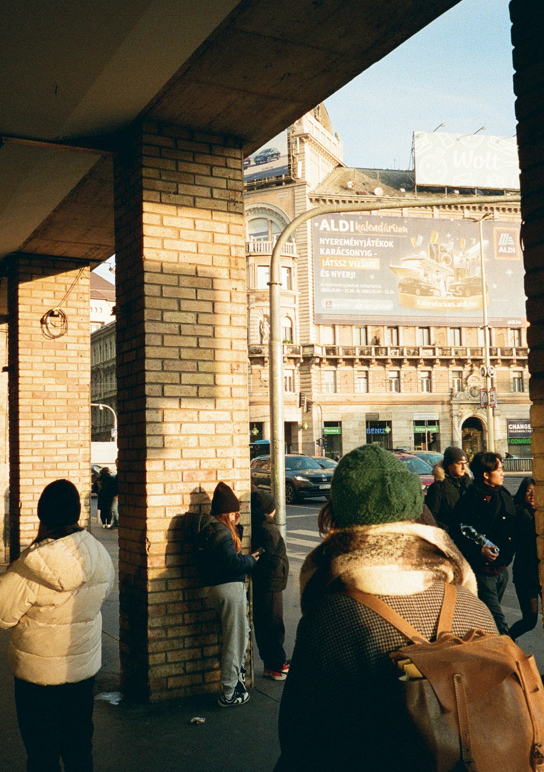 A group of people standing outside of a building photo – Free Street ...